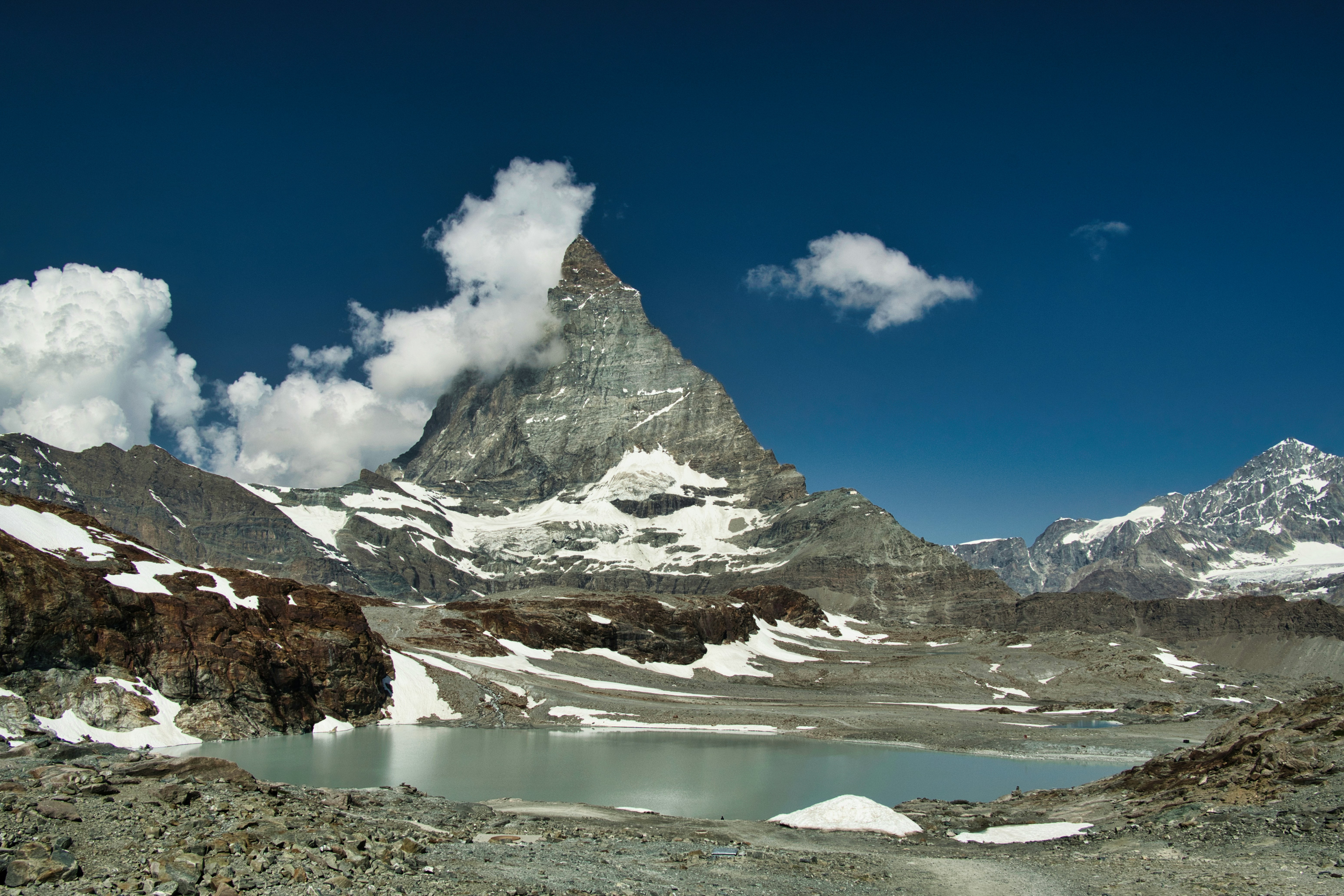 Pinnacle in the Snow: Sierra Peak Over a Glacier Teal Lake