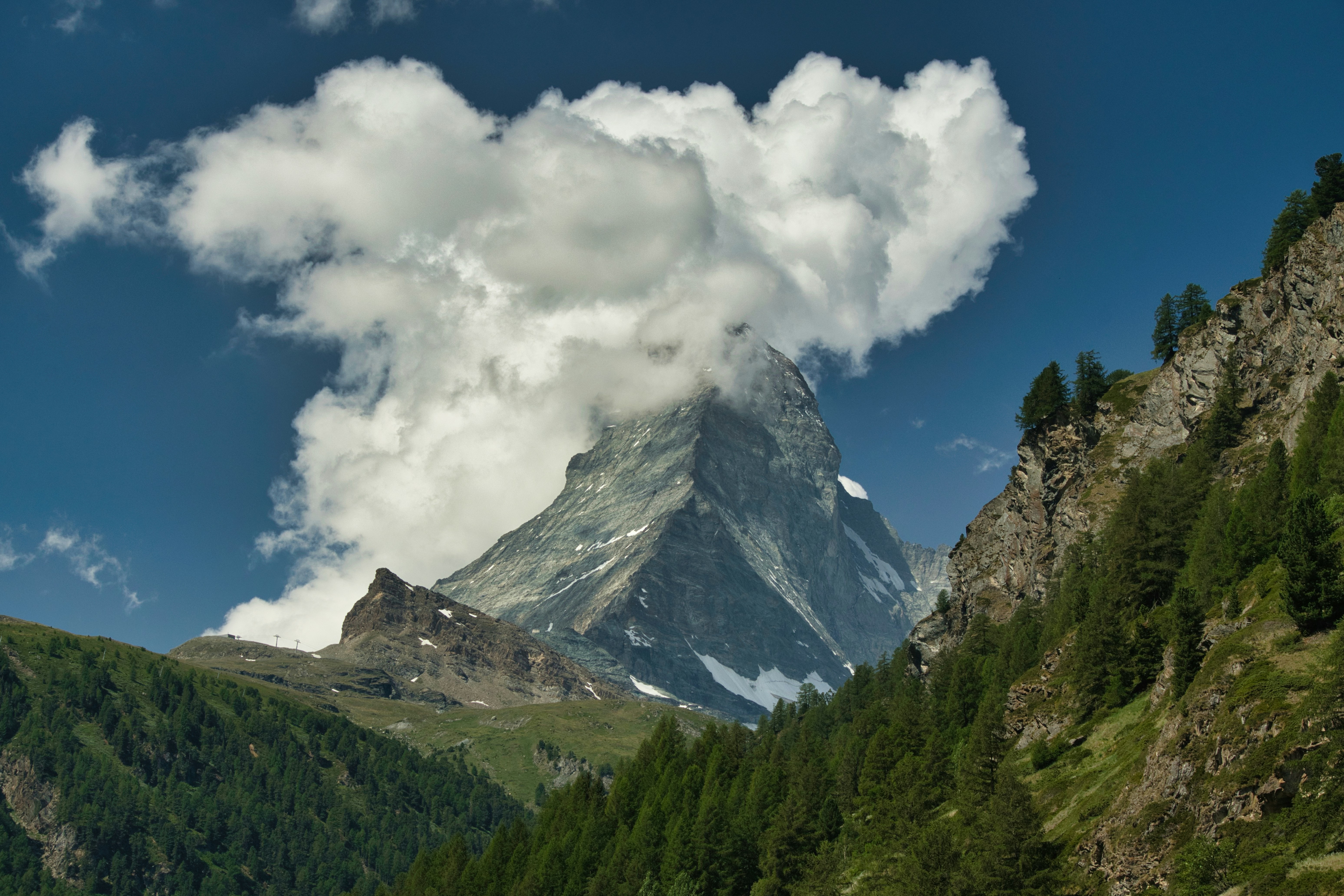 Cloud-Kissed Peak Rising Over Alpine Ridge