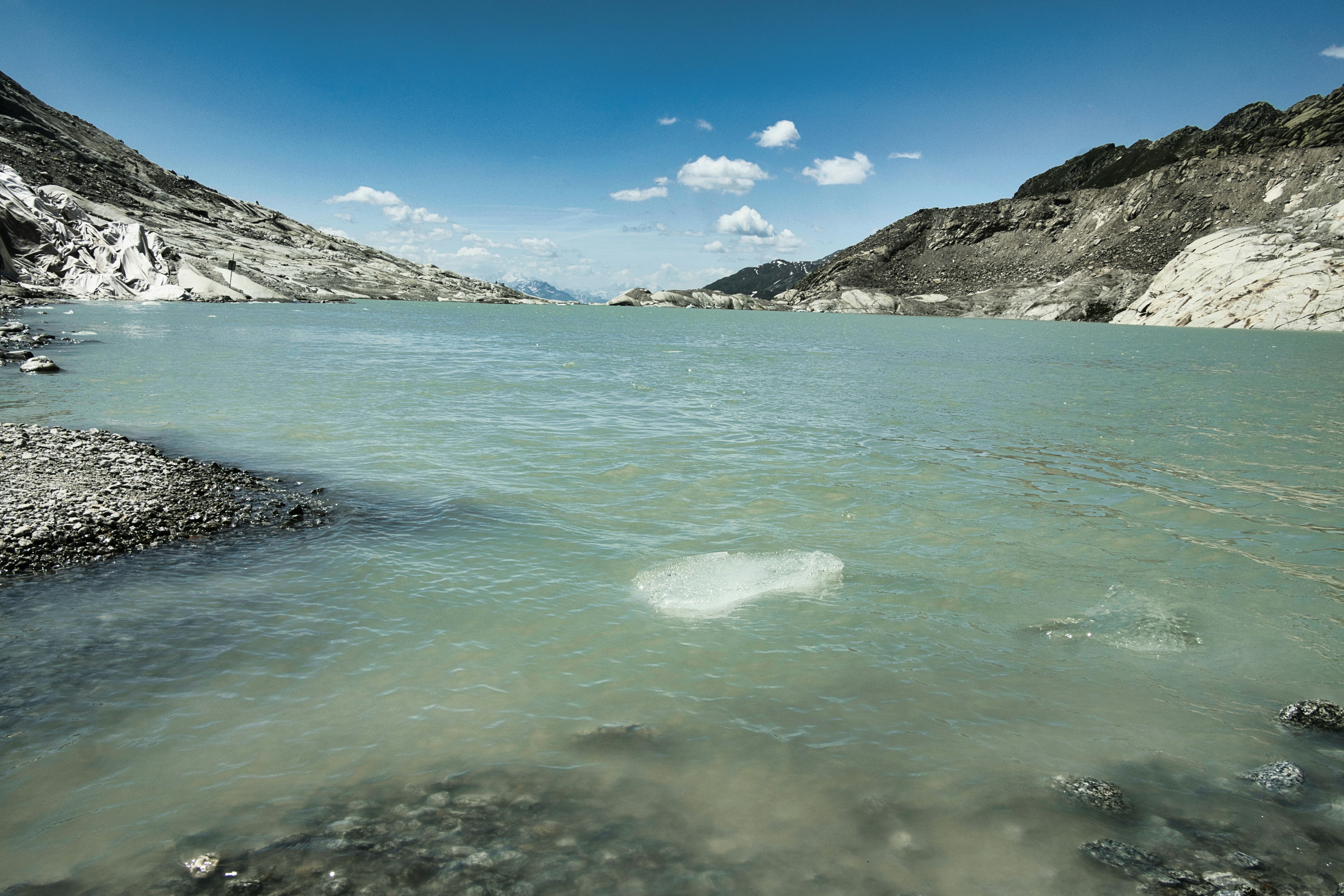 Turquoise Inlet Between Cliffed Ridges Under a Clear Sky