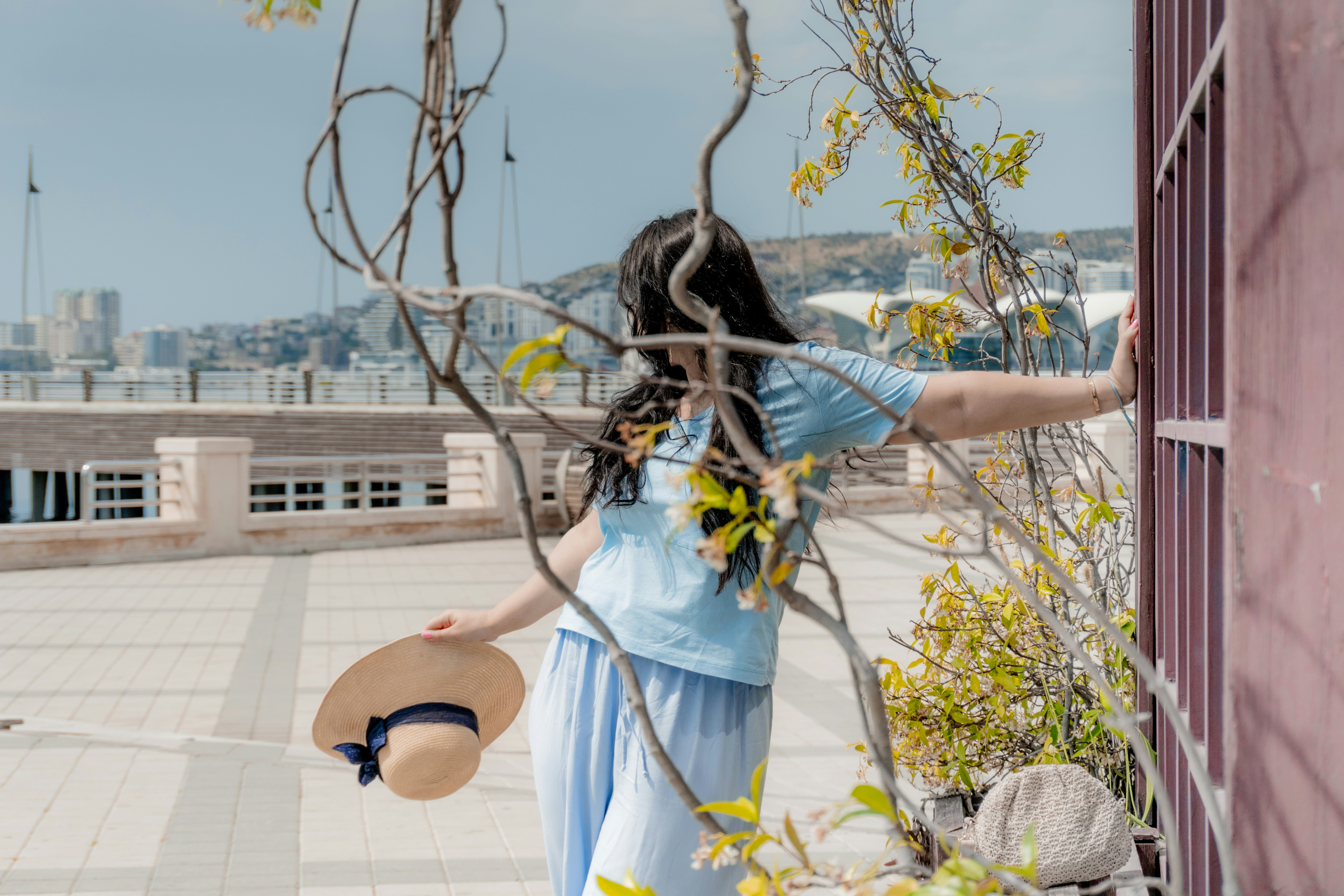 Brushstrokes of a Breeze: A Woman in a Sunlit Terrace