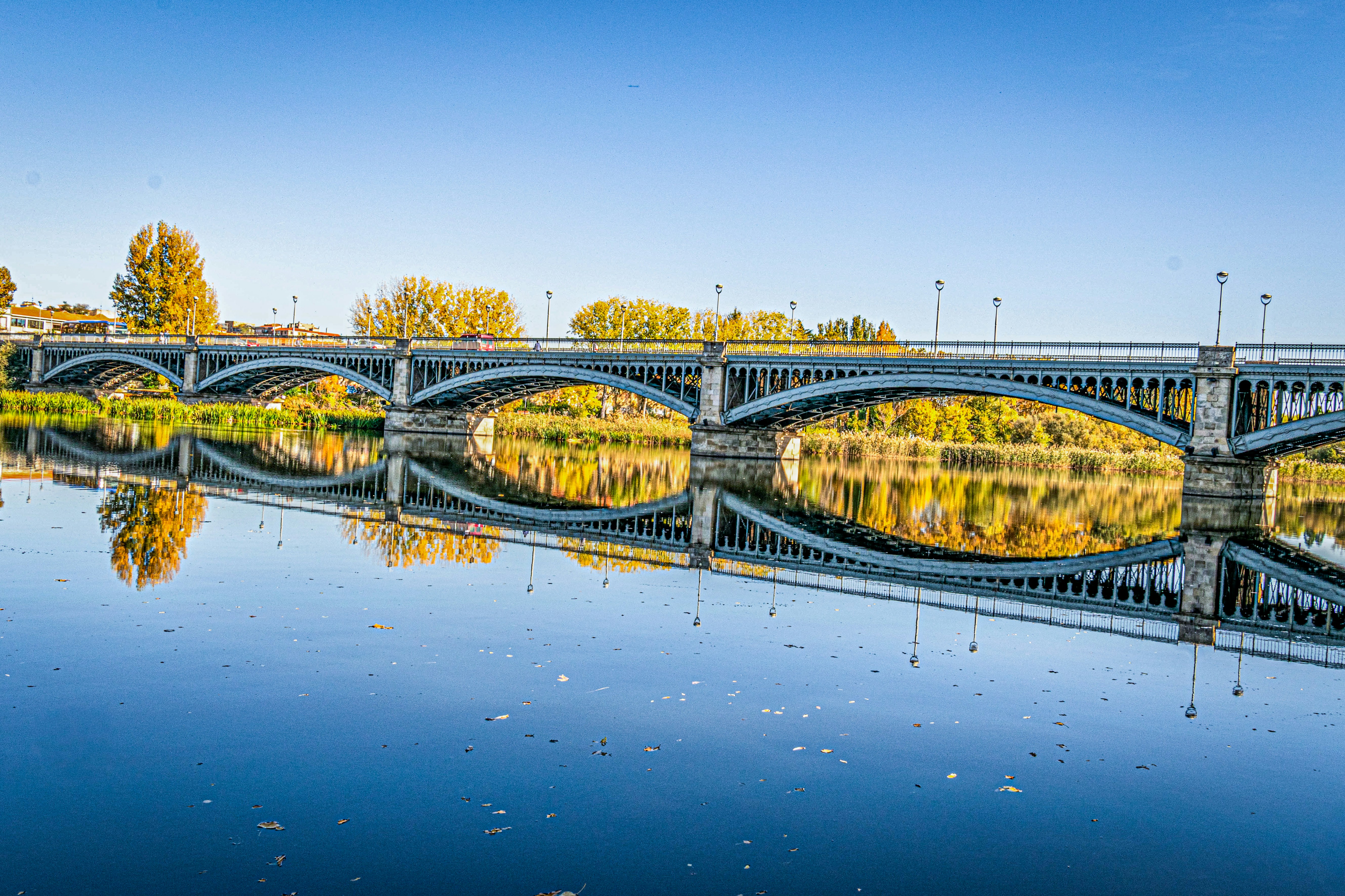 Mirror-Bridge over a Calm River at Golden Hour