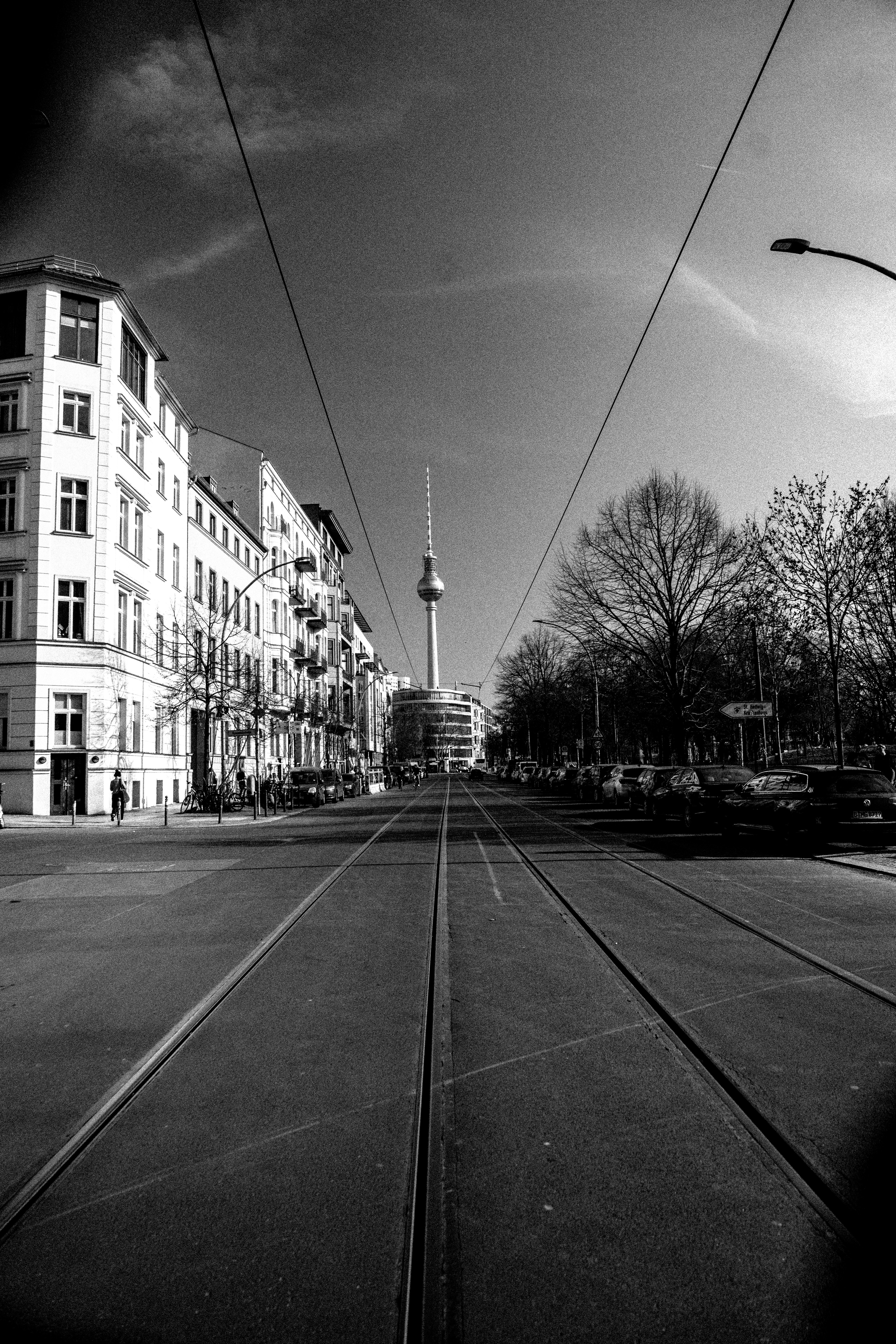 Silhouettes on Rails: A City Street Reaches for the Tower