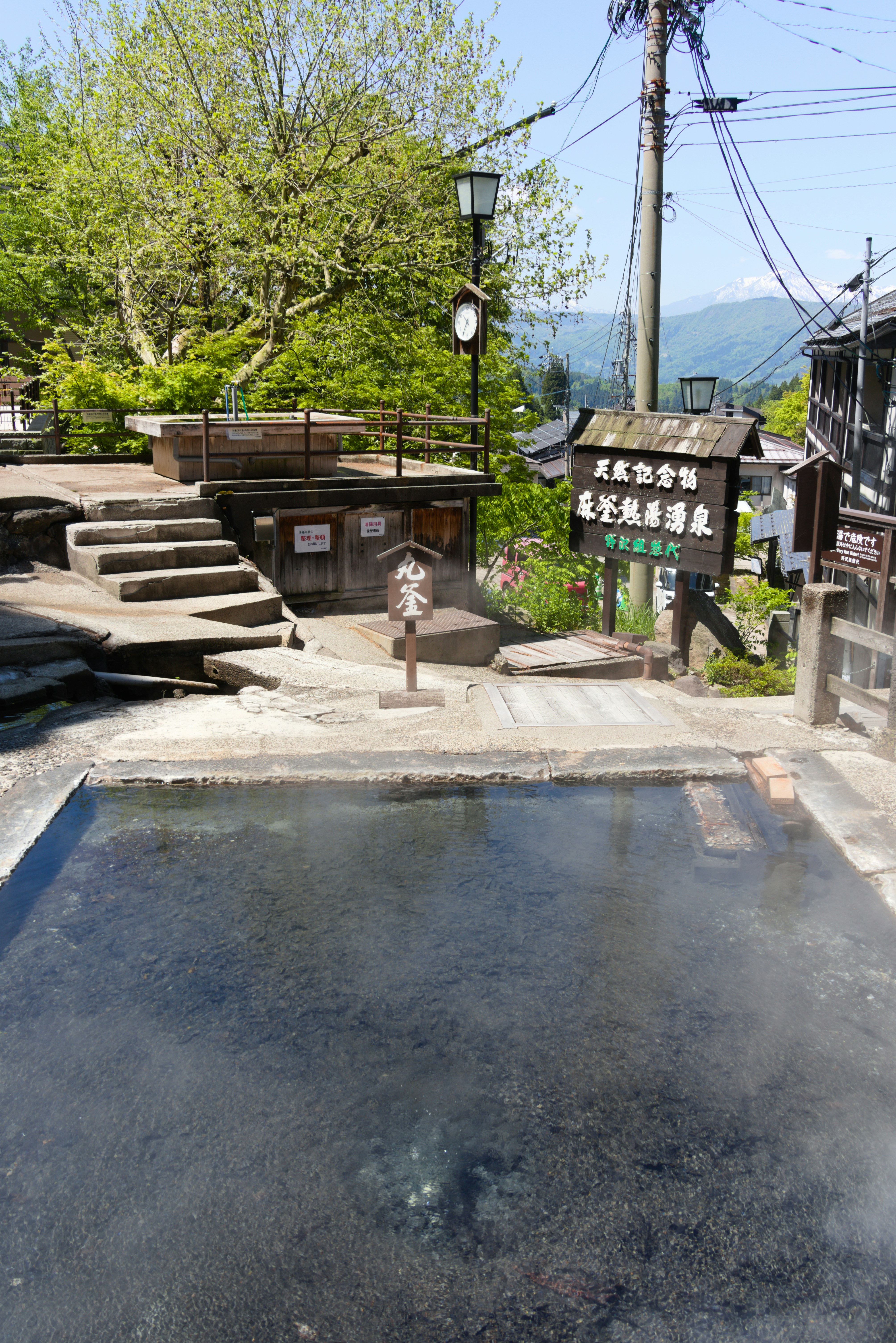 Steam Veil Over a Mountain Hot Spring Village