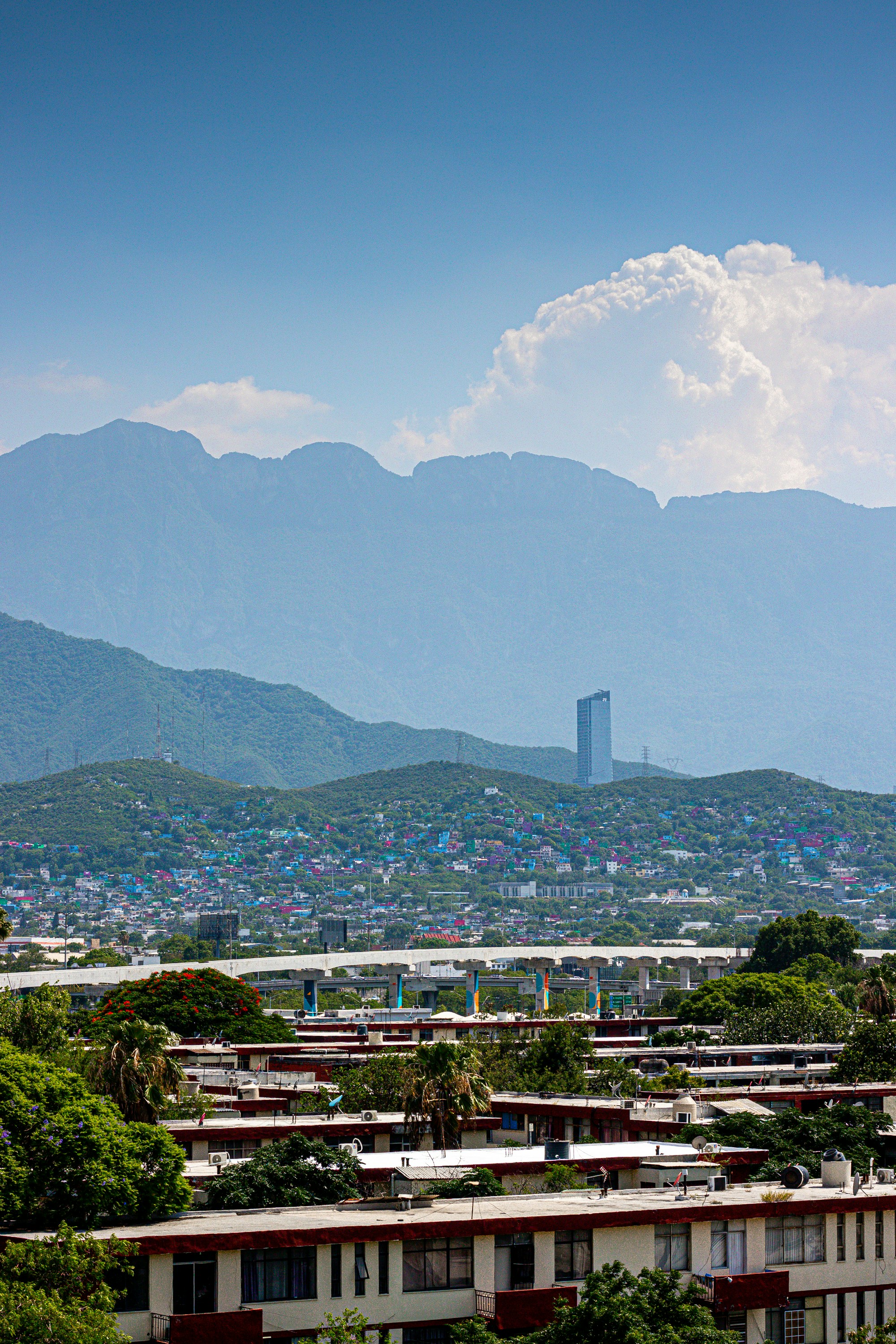 Urban Horizon Beneath Alpine Clouds