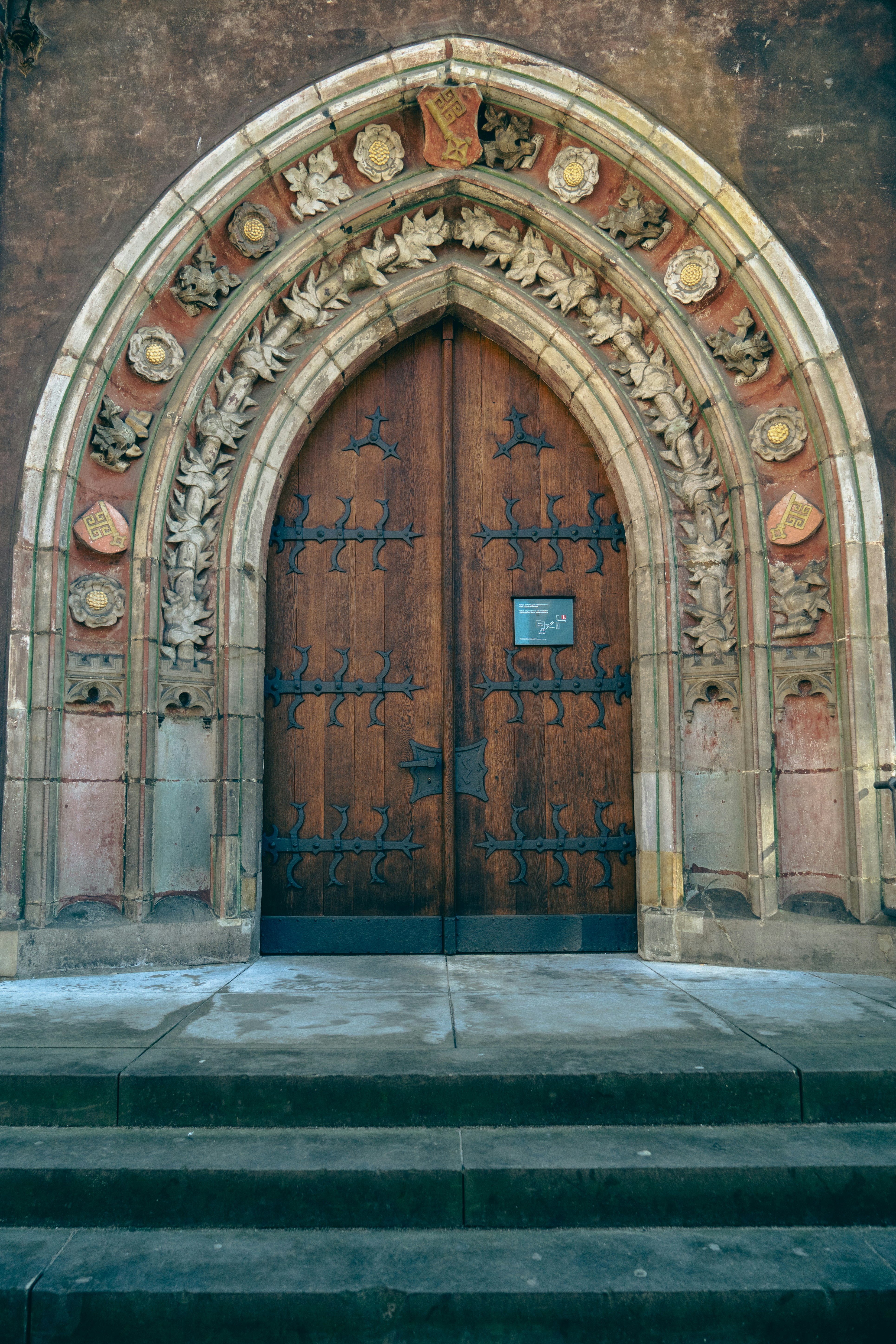 Archway of Time: Wooden Door within Ornate Gothic Portal