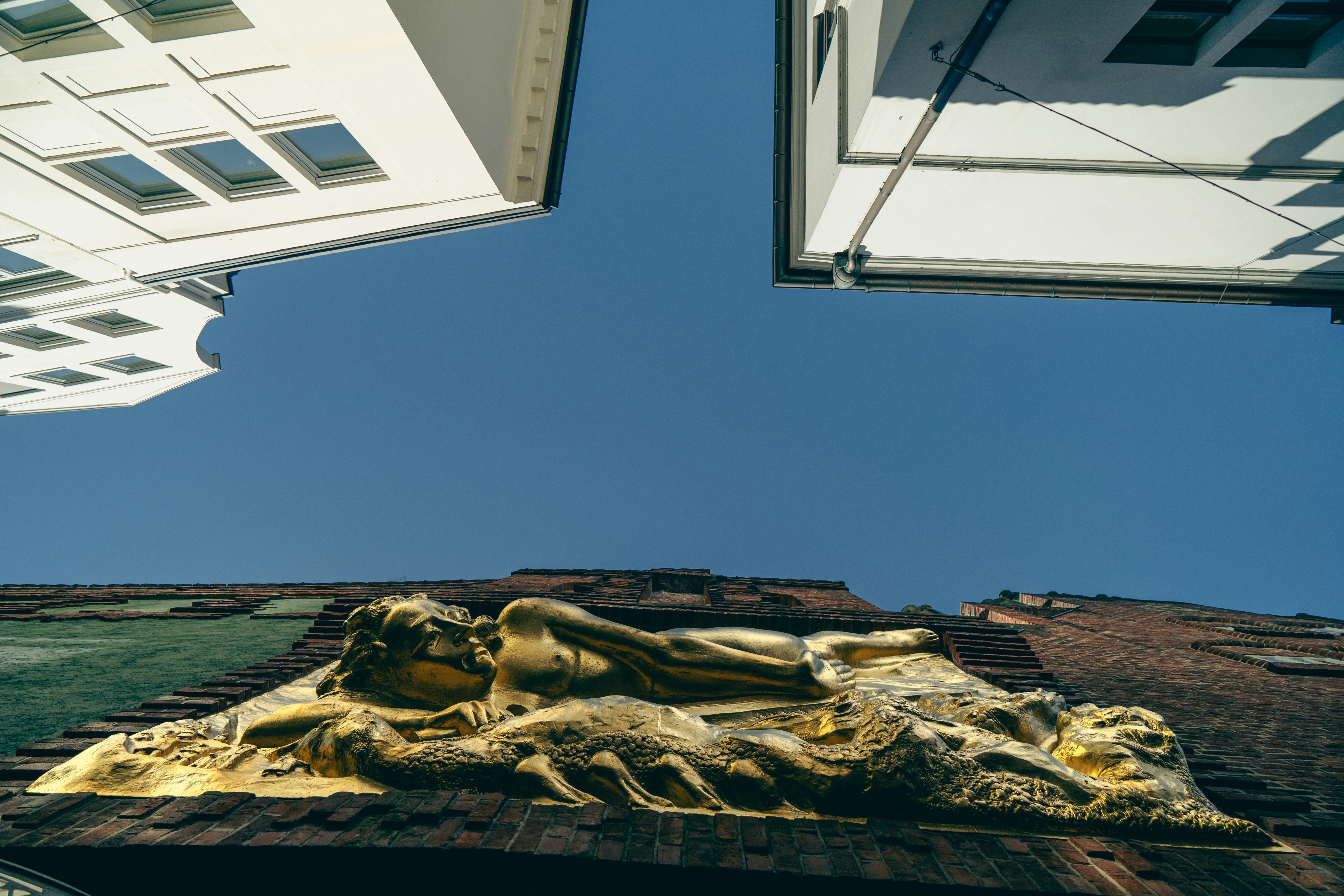 Floating on Stone: A Golden Recline Beneath Urban Steel