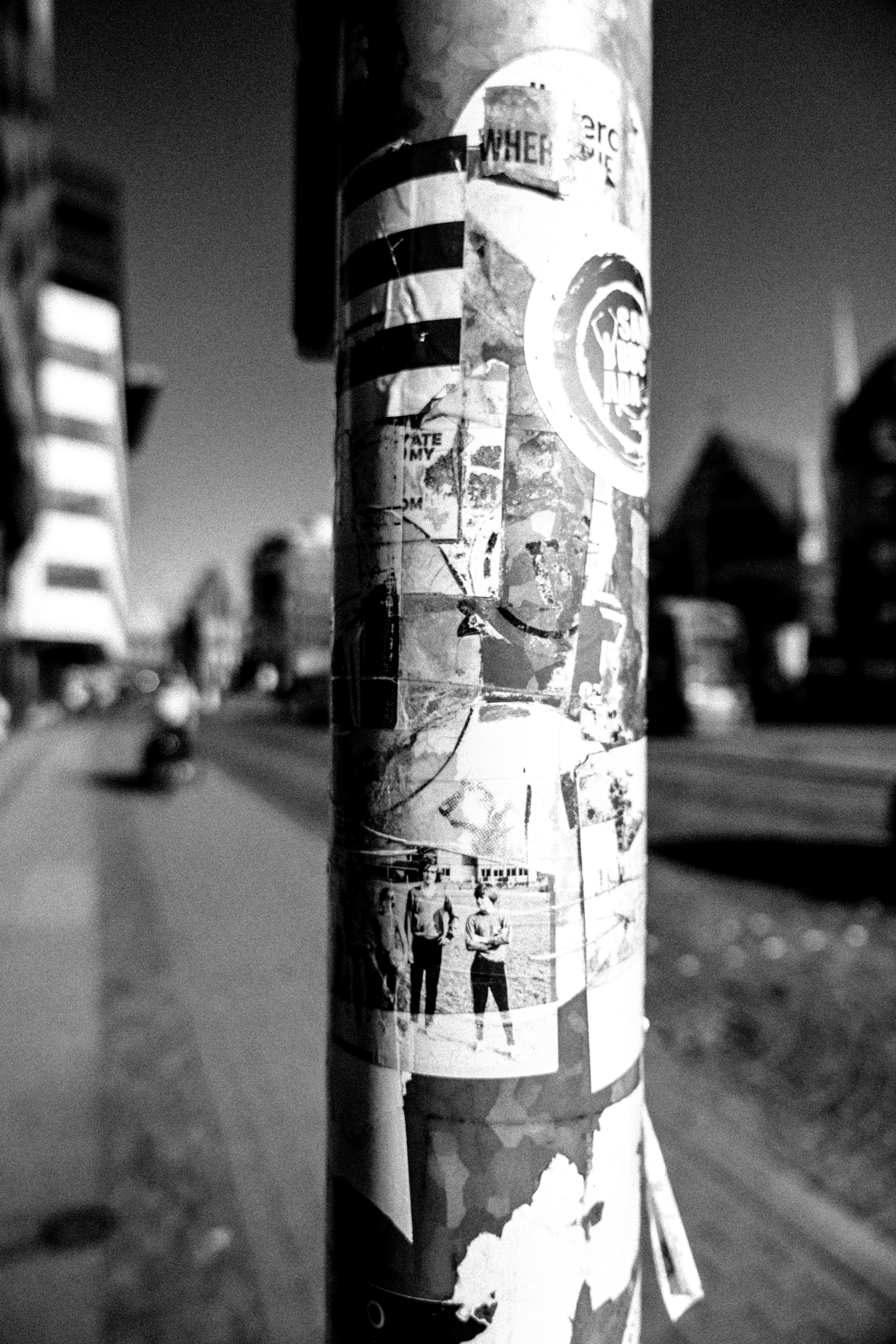 Urban Portrait of a Stickered Pole in Soft Focus Street