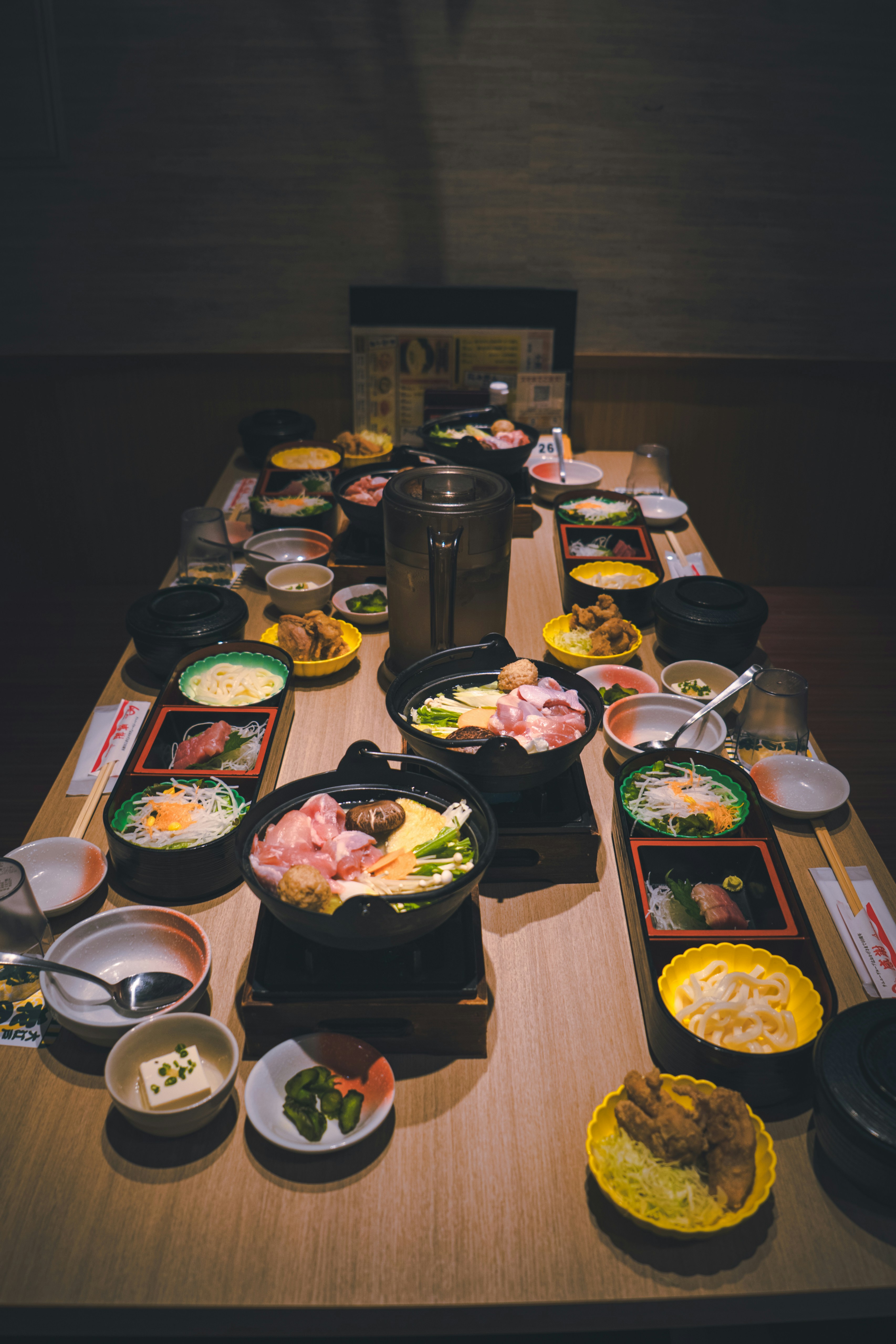 Shared Feast: A Long Table of Japanese Hot Pot and Side Dishes
