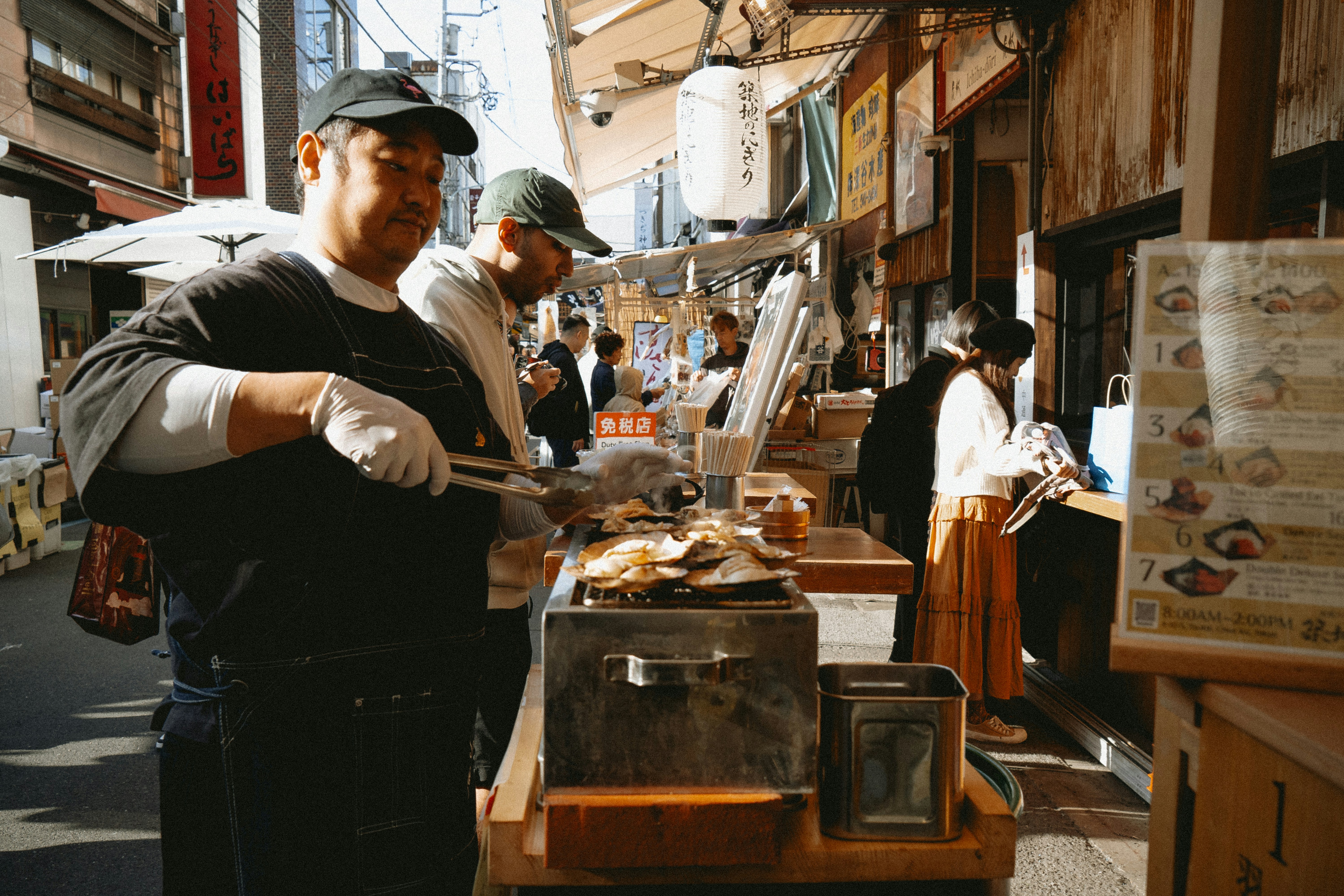 Street Grill in Focus: Chef at Work Amid Market bustle