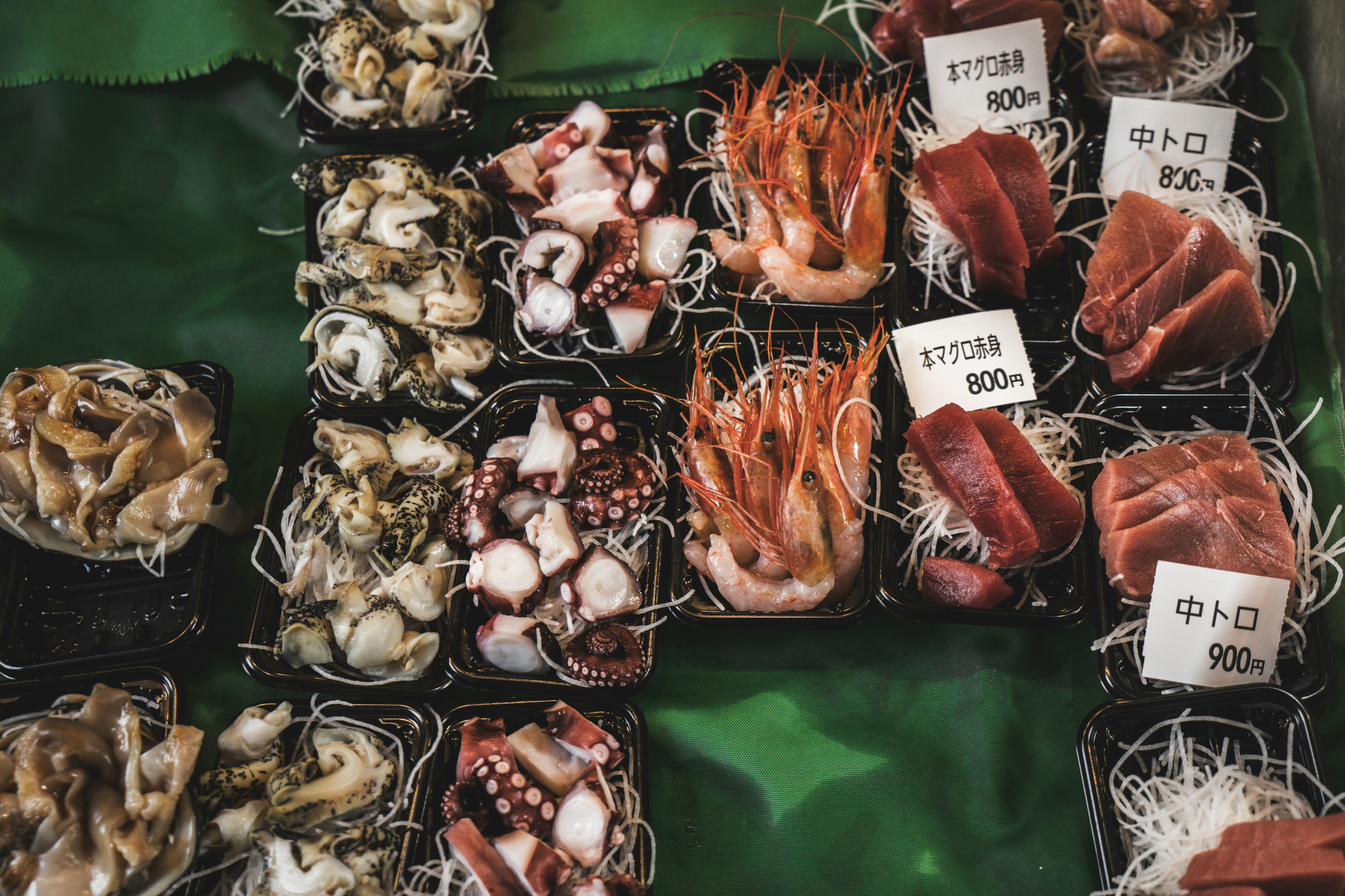 Vibrant Seafood Market: Assorted Fresh Octopus, Shrimp, and Tuna for Sale