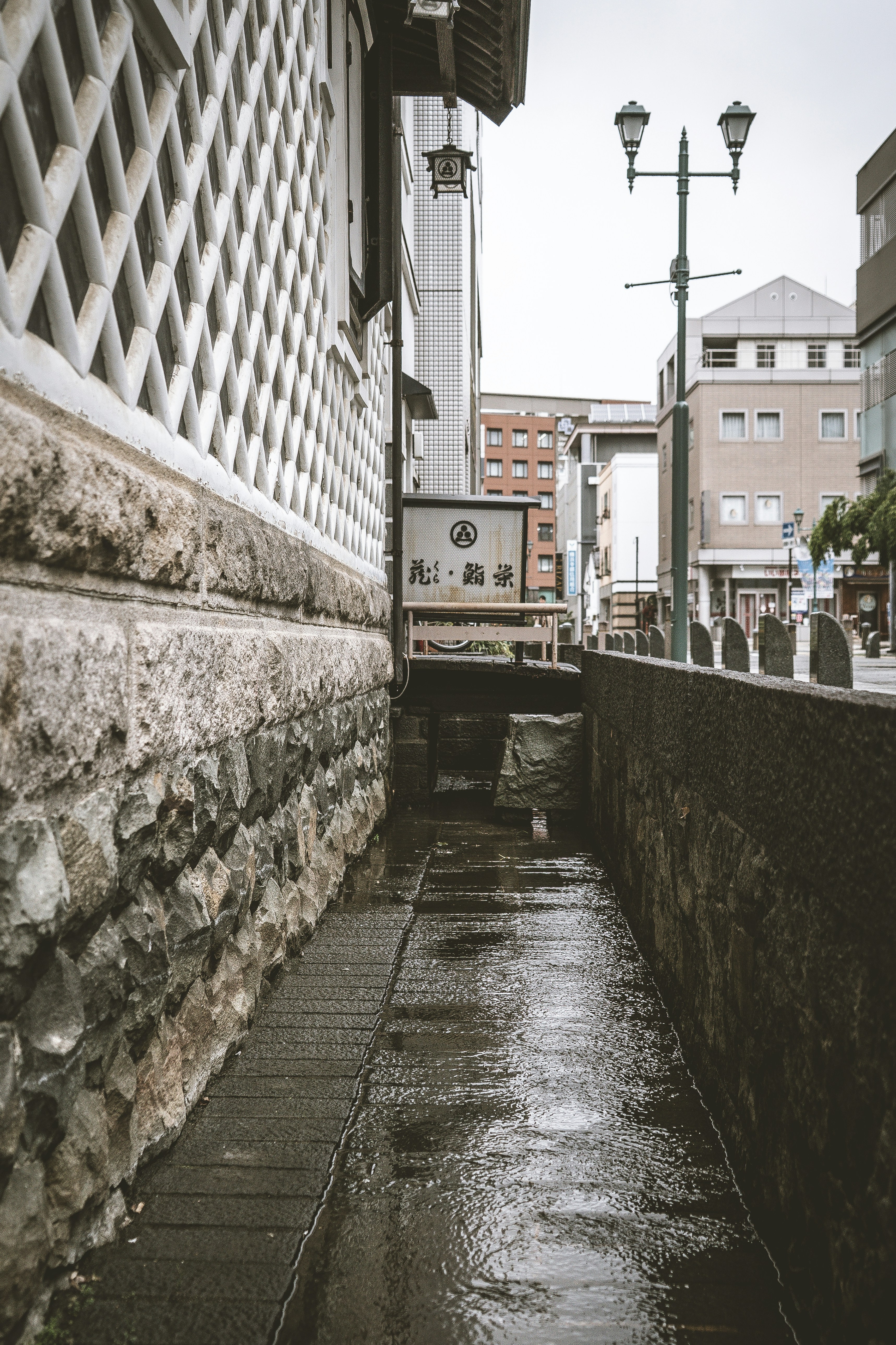 Quiet Waterway Between Stone Walls in an Urban Alley