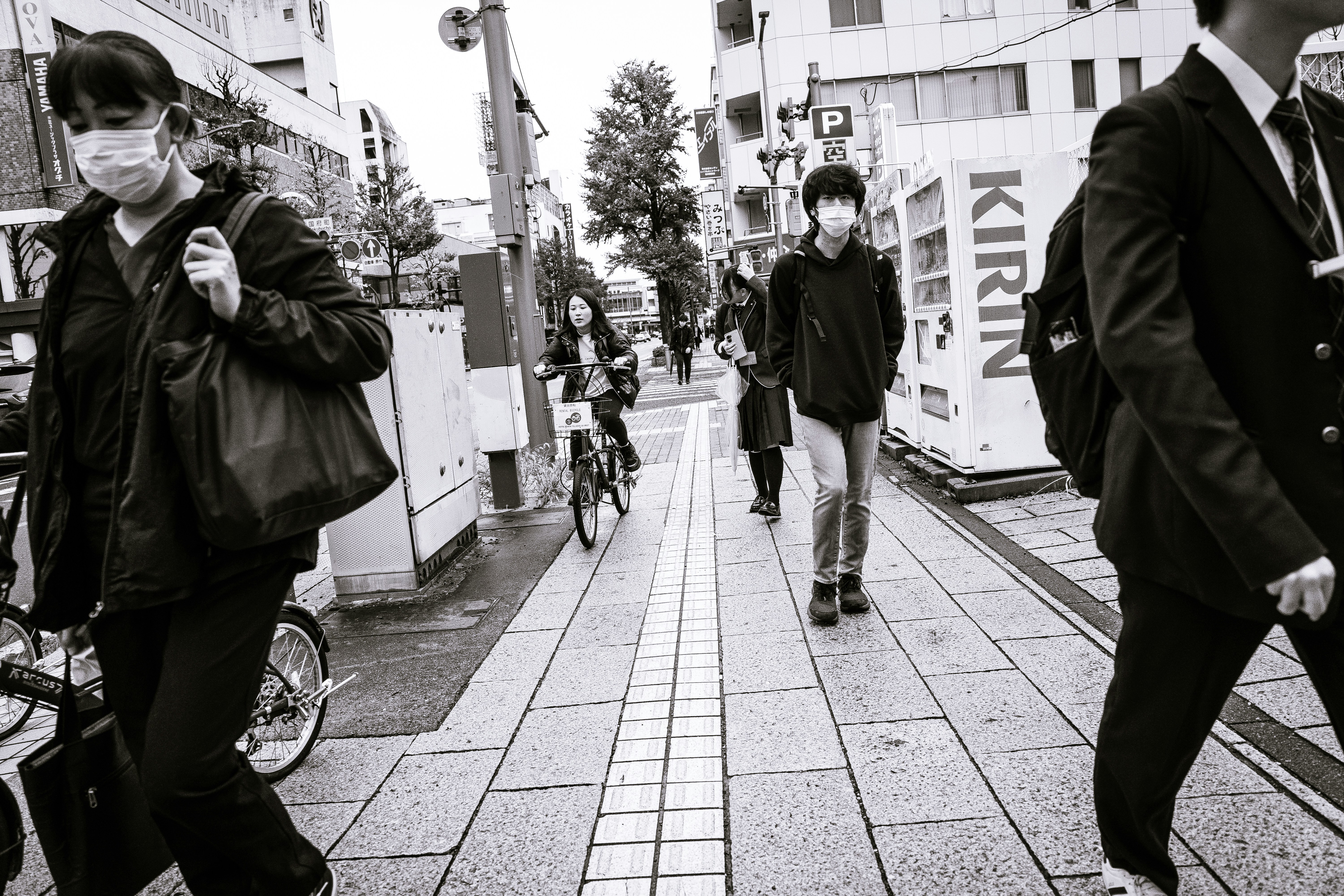 Urban Corridor: Quiet Figures in a Busy Street
