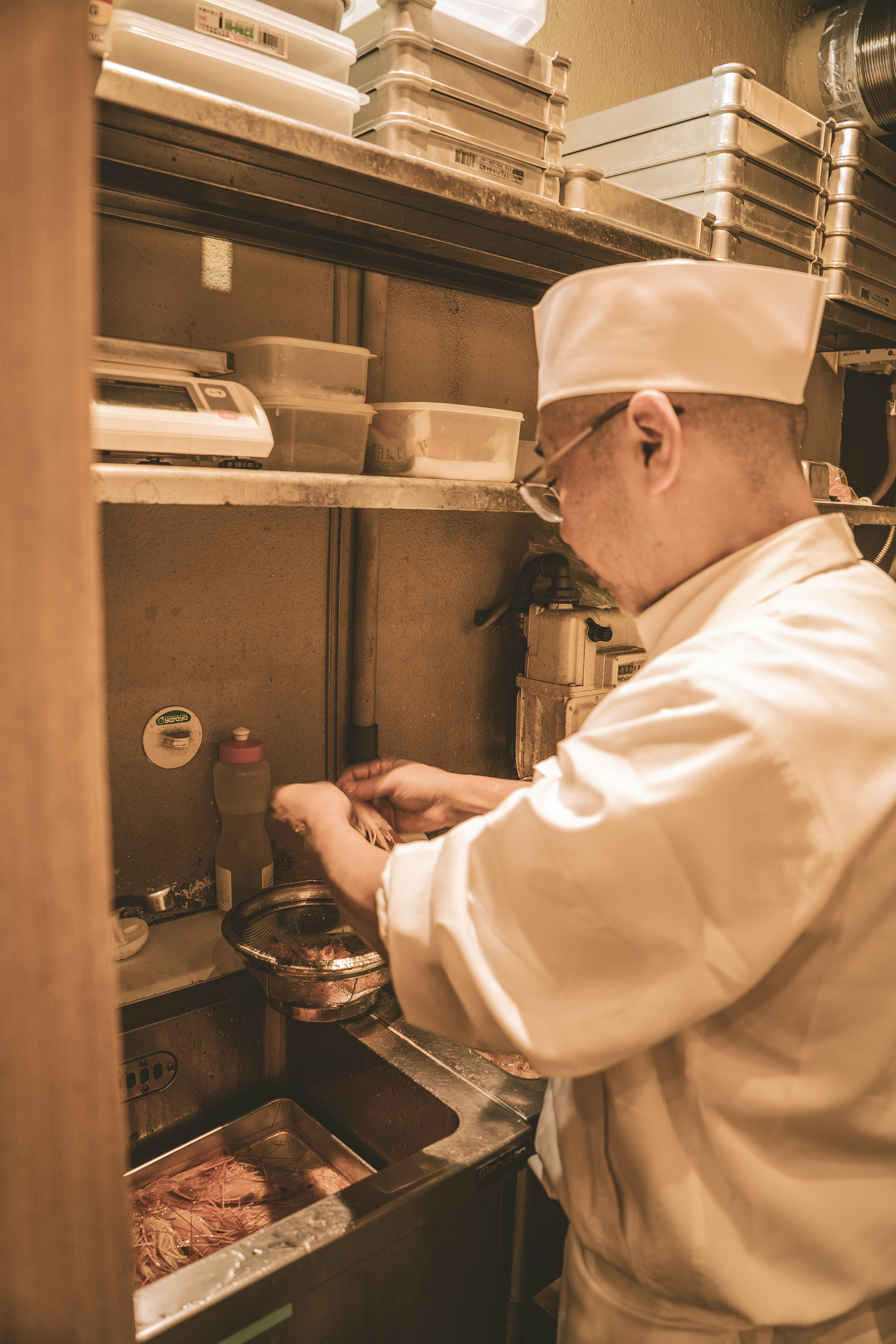Chef in a warm kitchen: precise craft under pressure