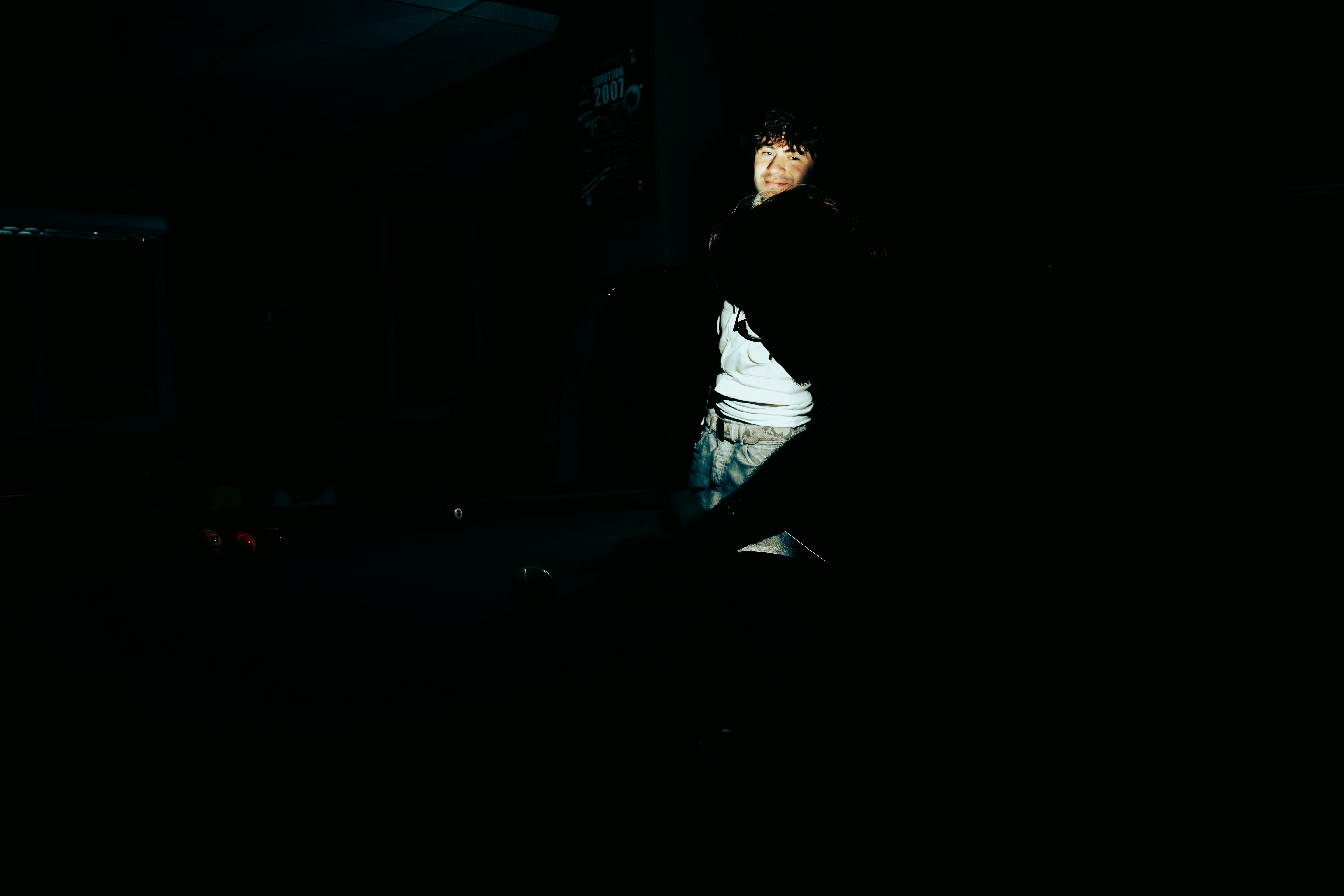 Midnight Spotlight: A Lone Performer in Low Light