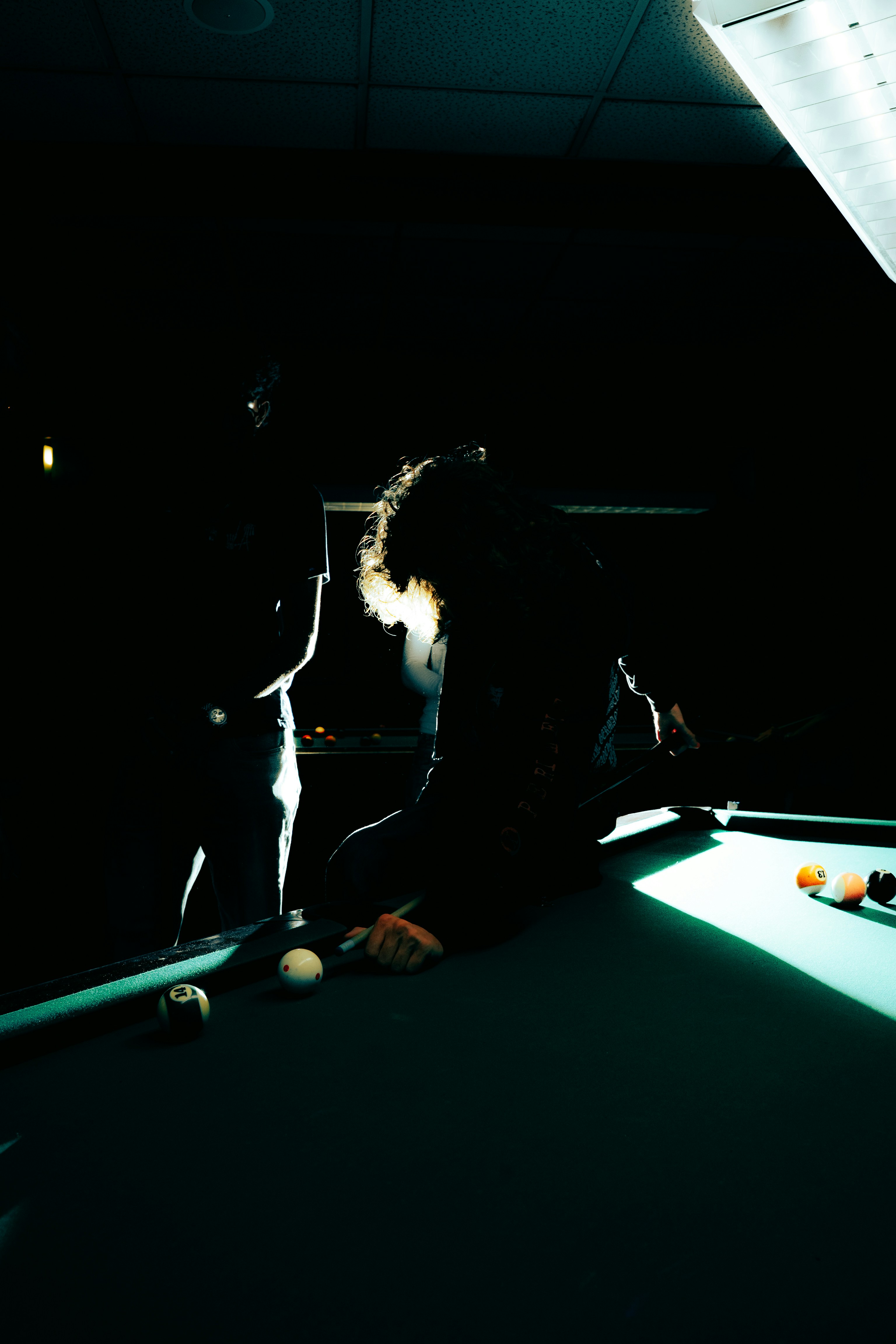 Shadowed Break: A Quiet Stride Over the Green Felt