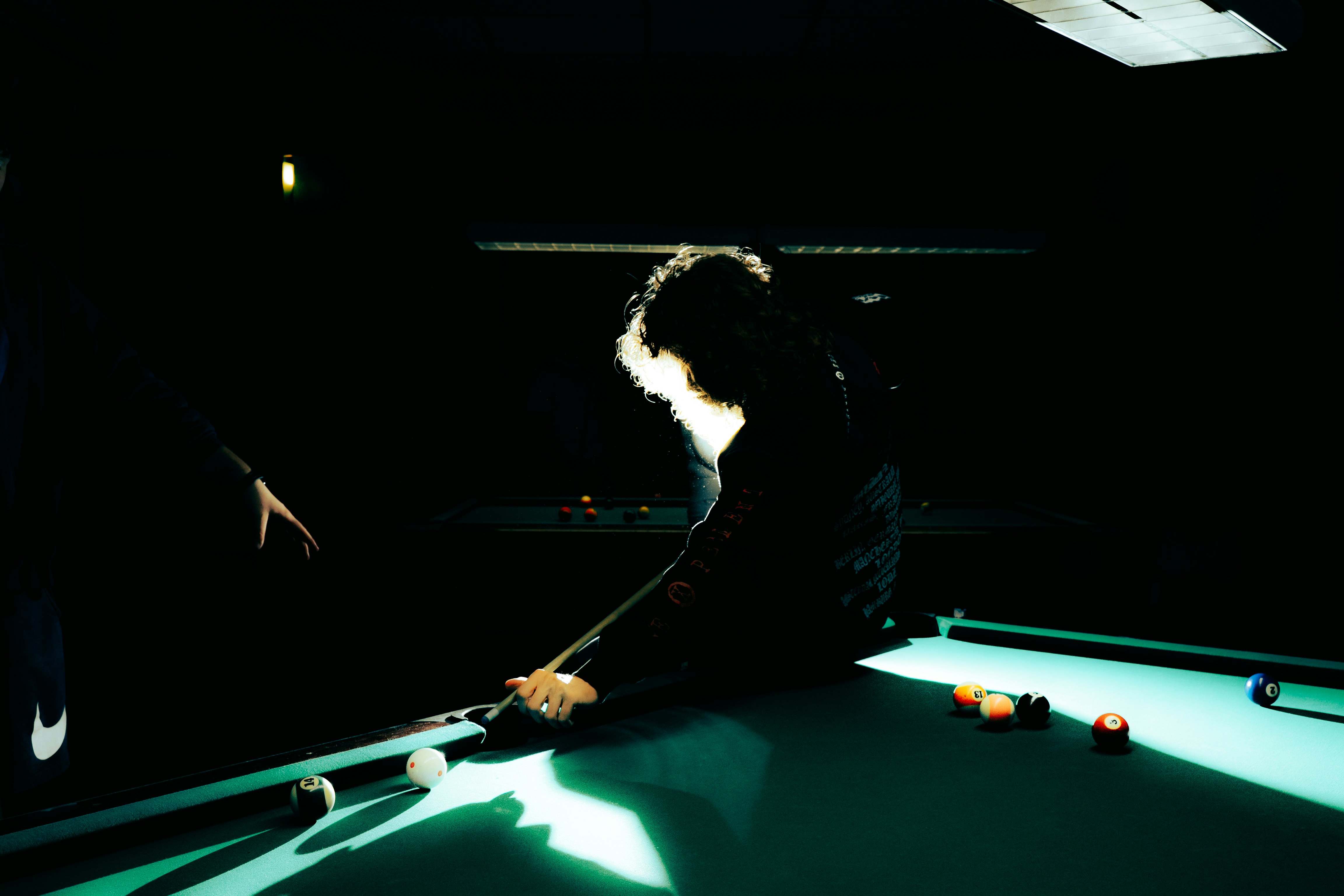 Shadowed Focus: A Billiards Moment in Neon Glow