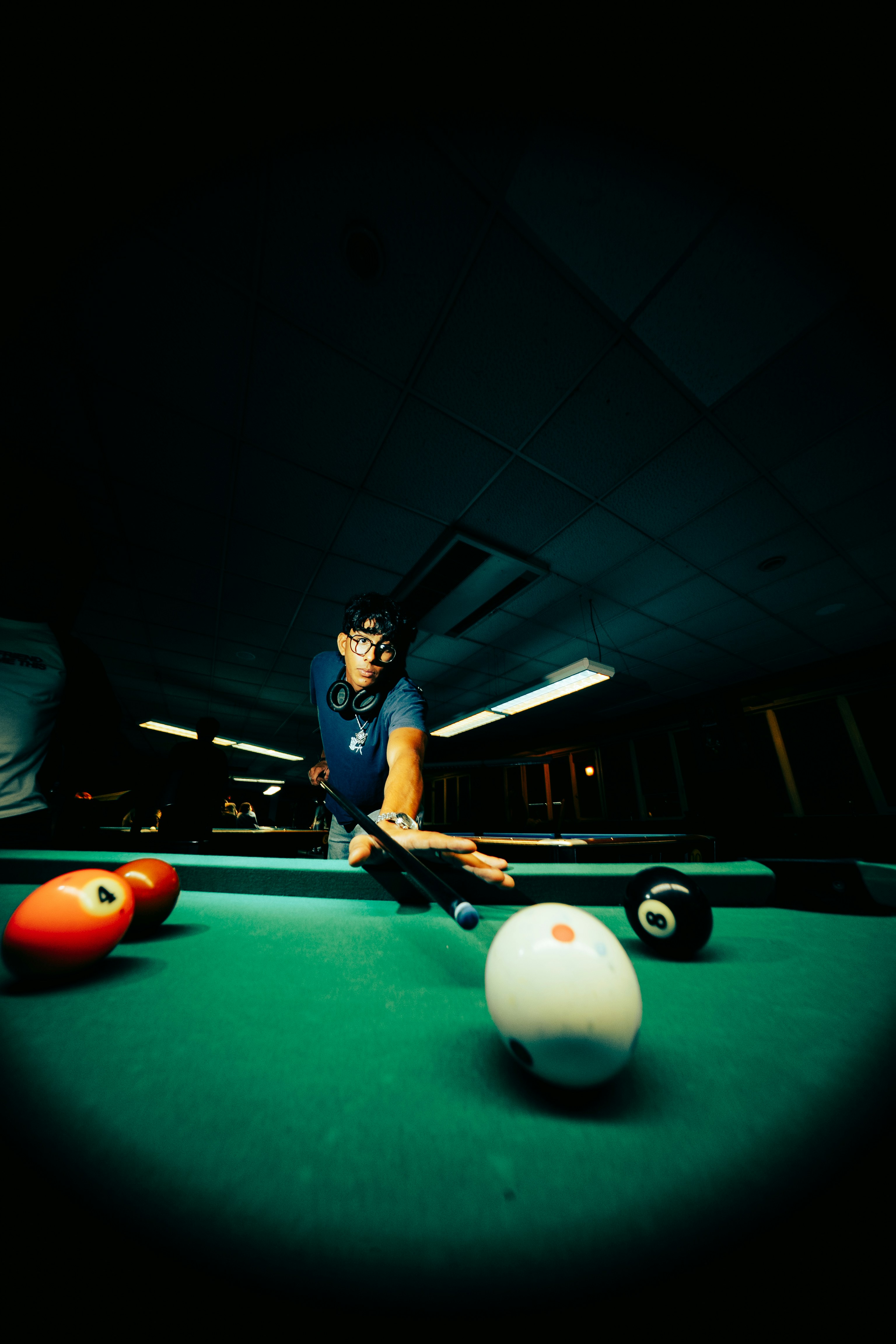 Low-angle Break: Hallway of Green Felt and Focused Shot at the Table