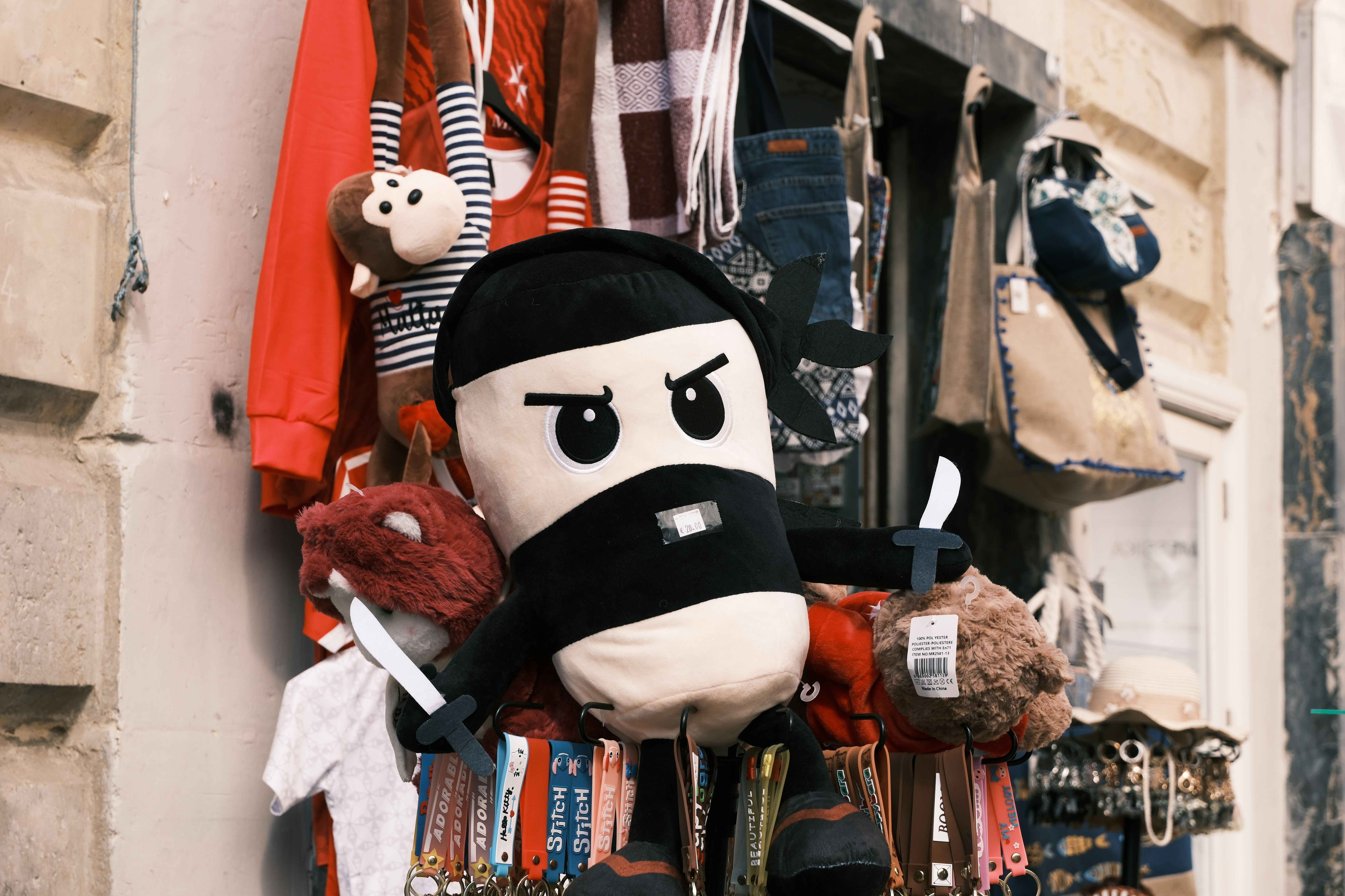 Shopfront Mascot: A Plush Ninja Watching Over Colorful Trinkets