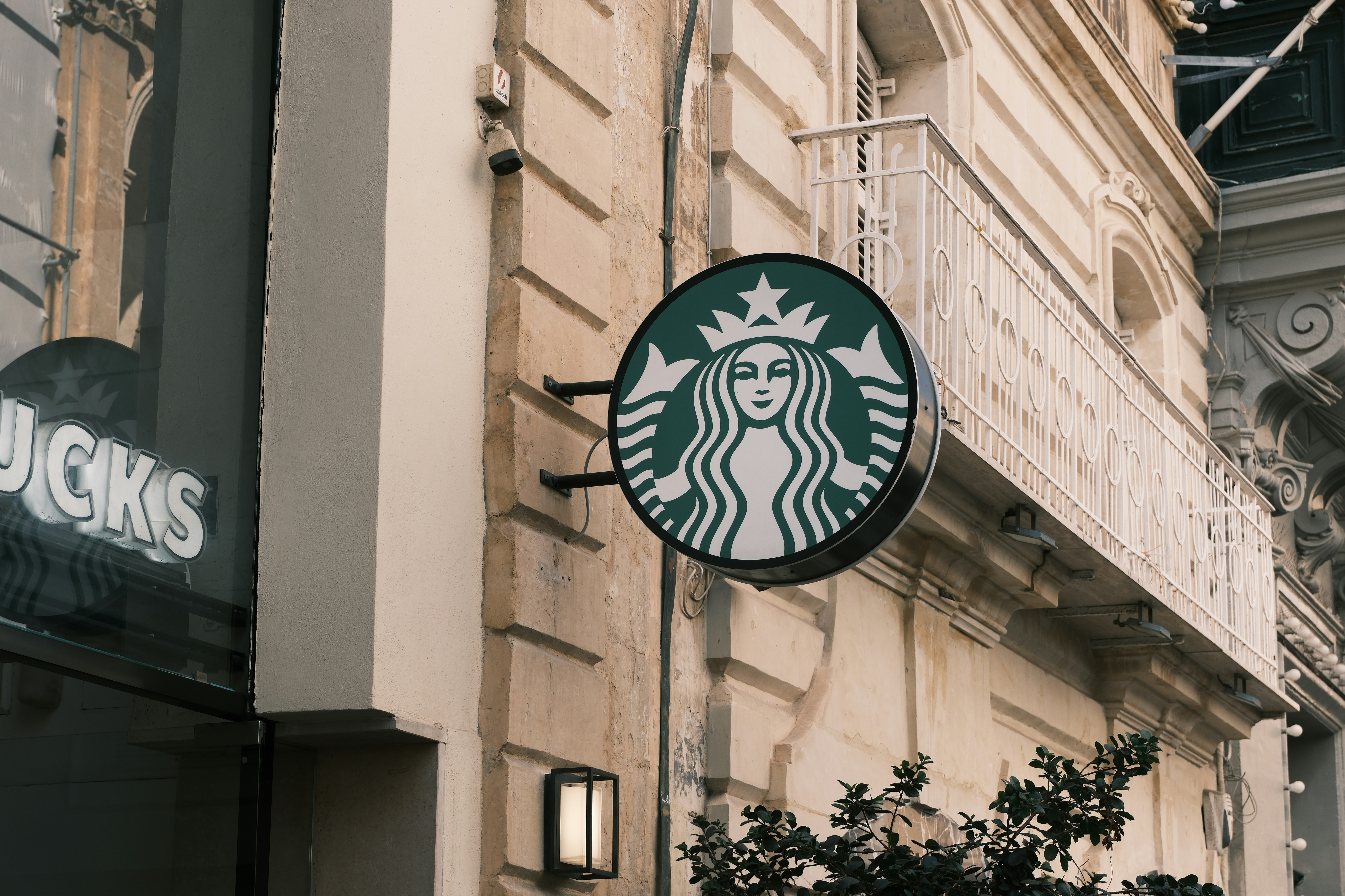 Circular Star: Starbucks Sign Anchored on a Historic Facade