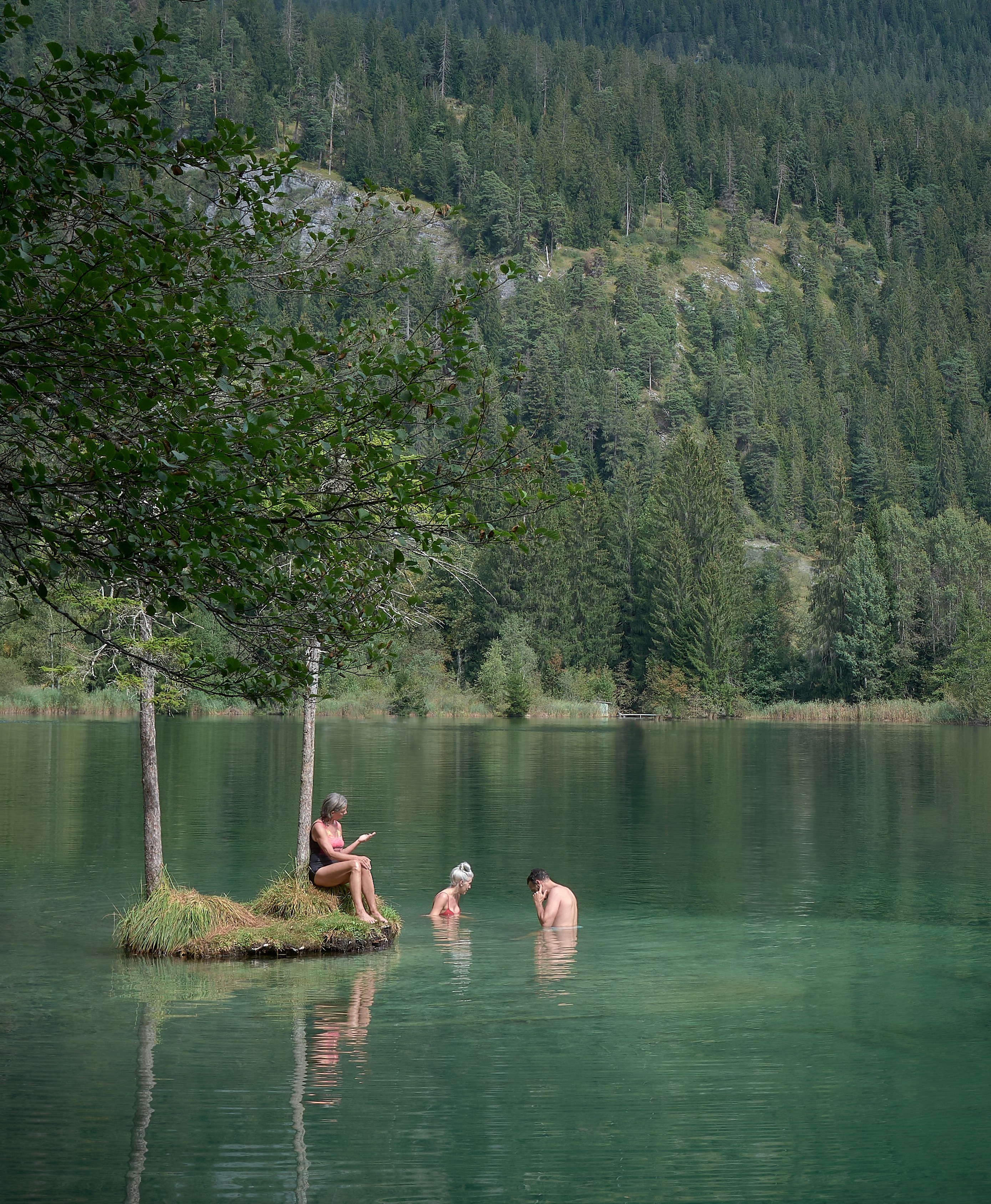 Island of Rest: A Family Moment on a Quiet Alpine Lake