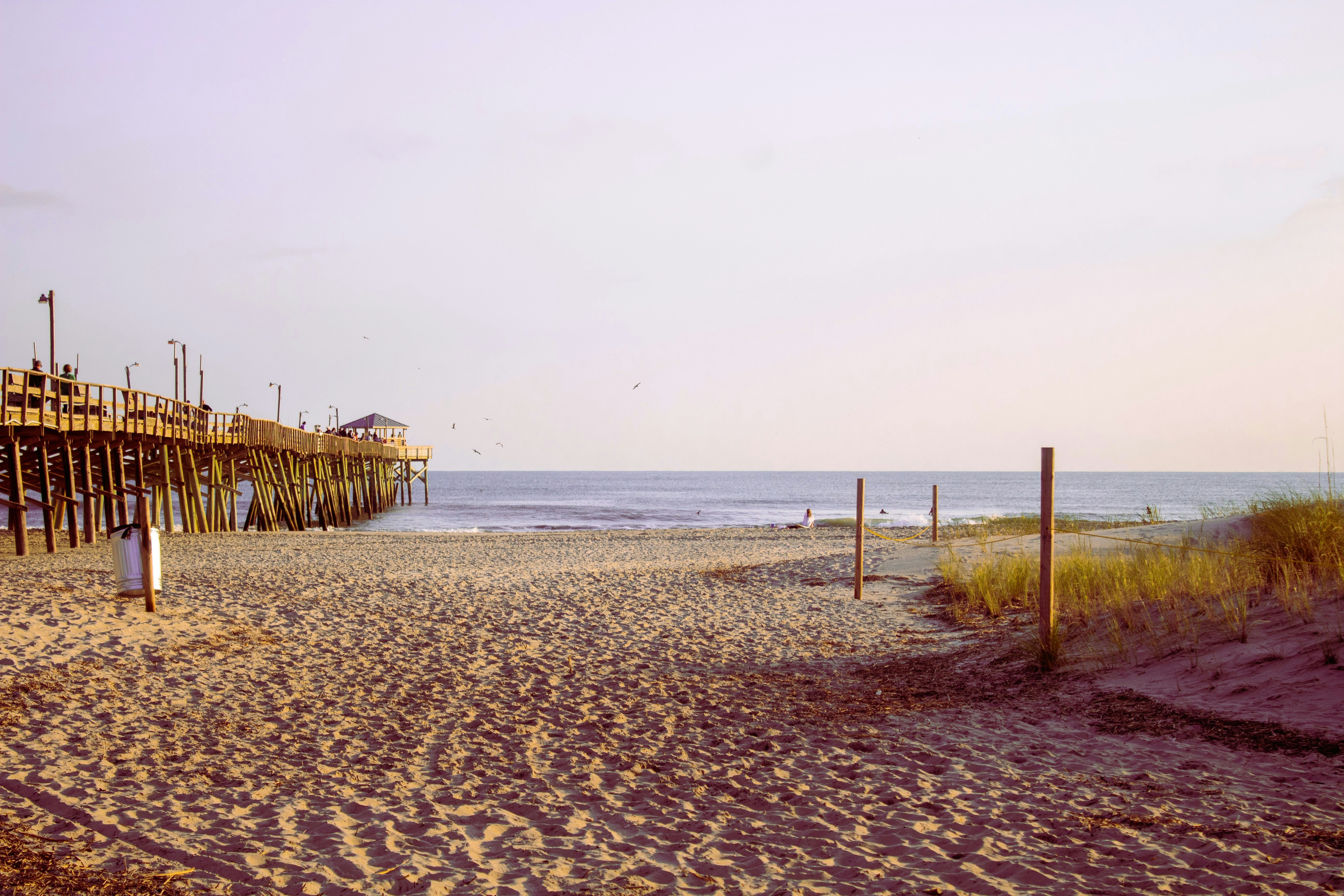 Footprints in warm sand lead to a quiet Atlantic horizon