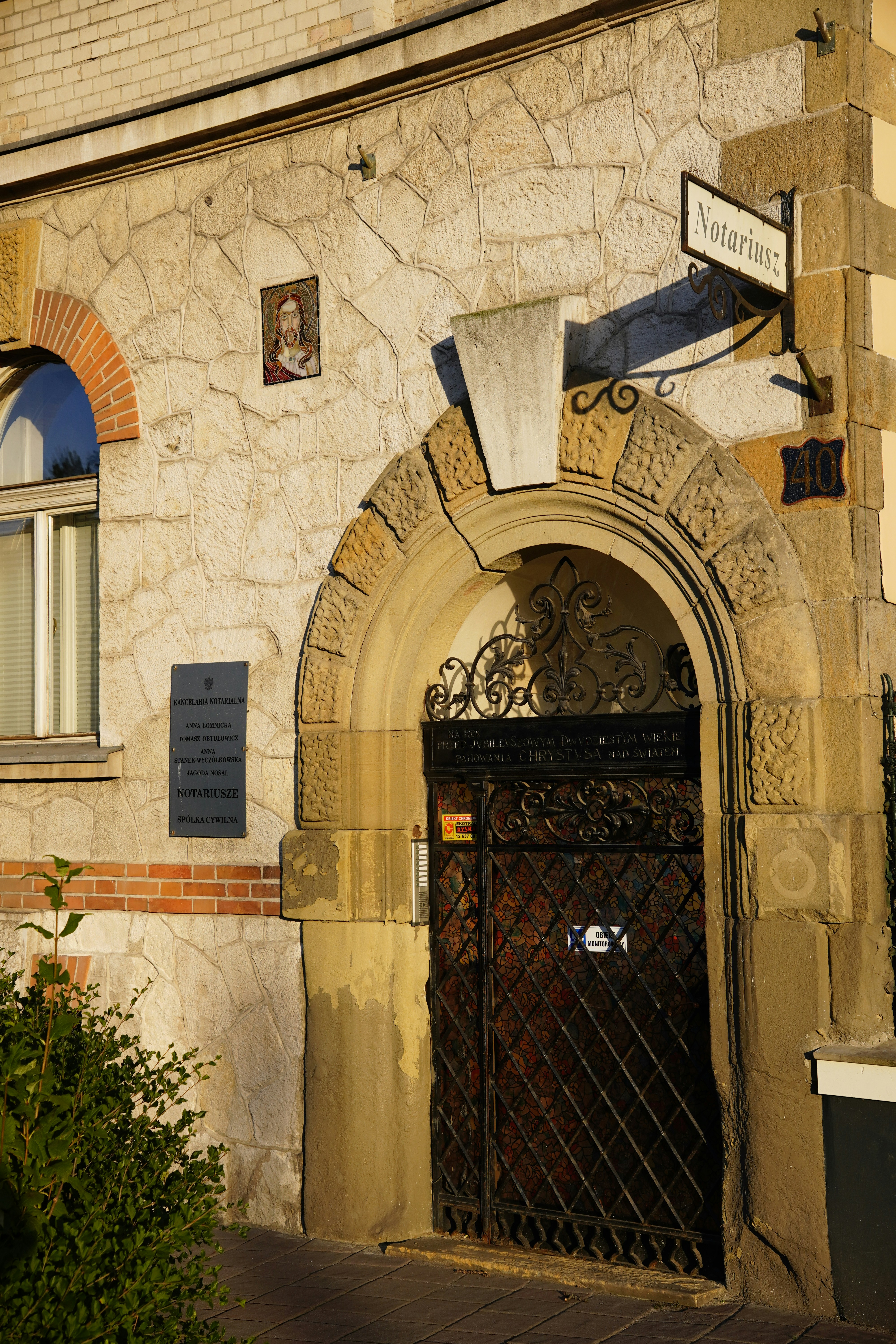 Stone Archway and Wrought-Iron Gate: Cornerstone of a Historic Facade