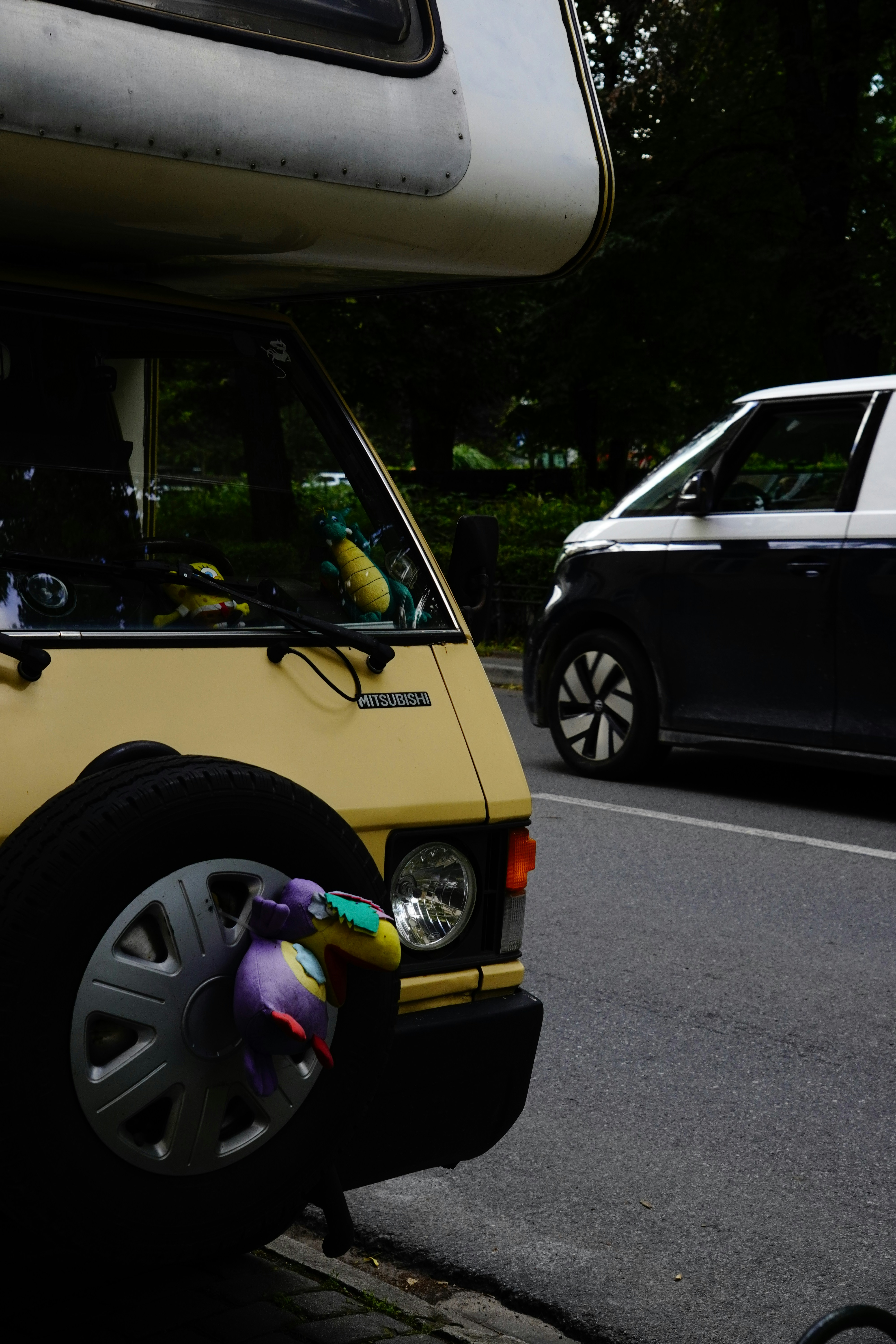 Front-Left Camper: A Curious Toy Emerges from the Wheel Well
