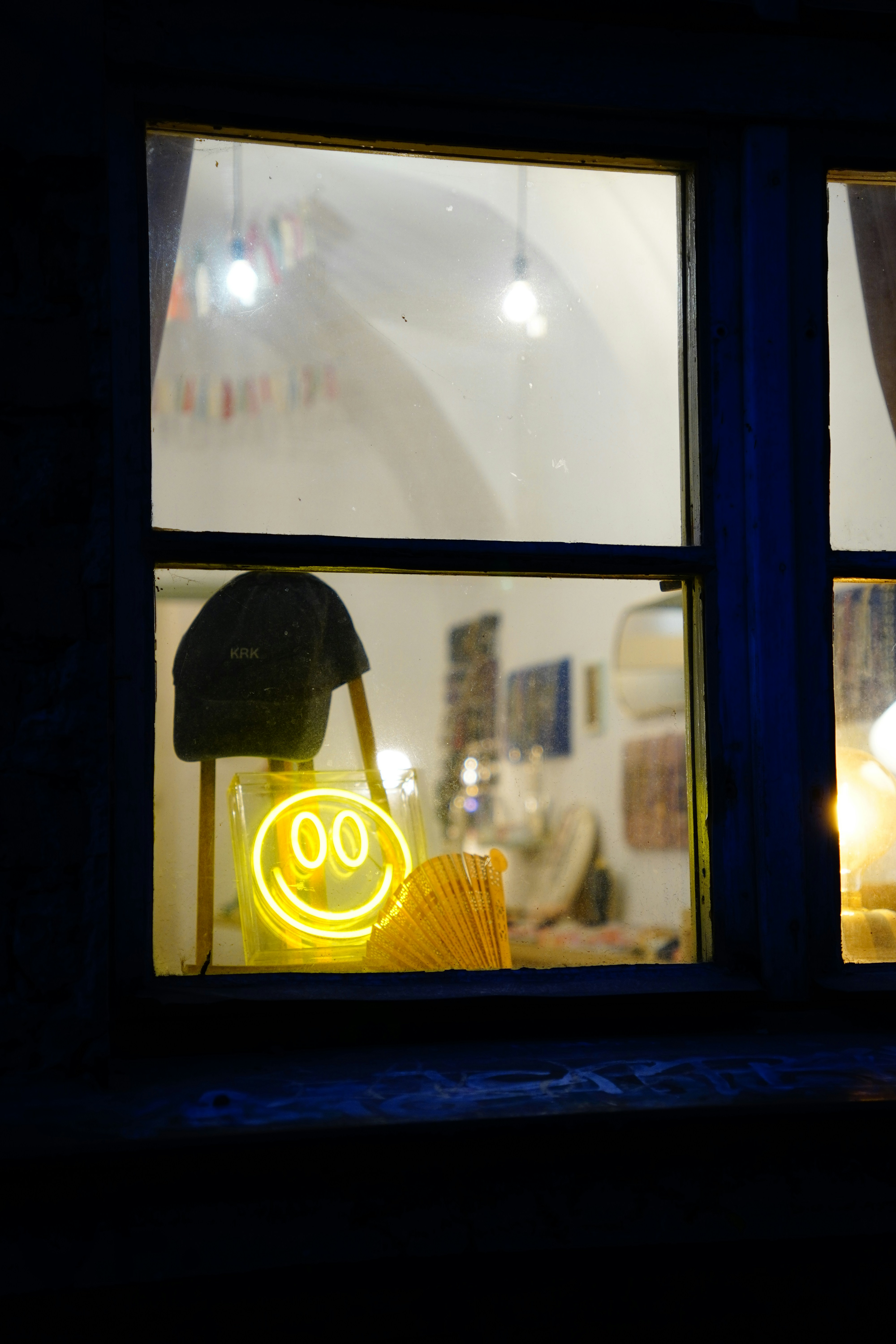 Neon Smiles Through a Shop Window