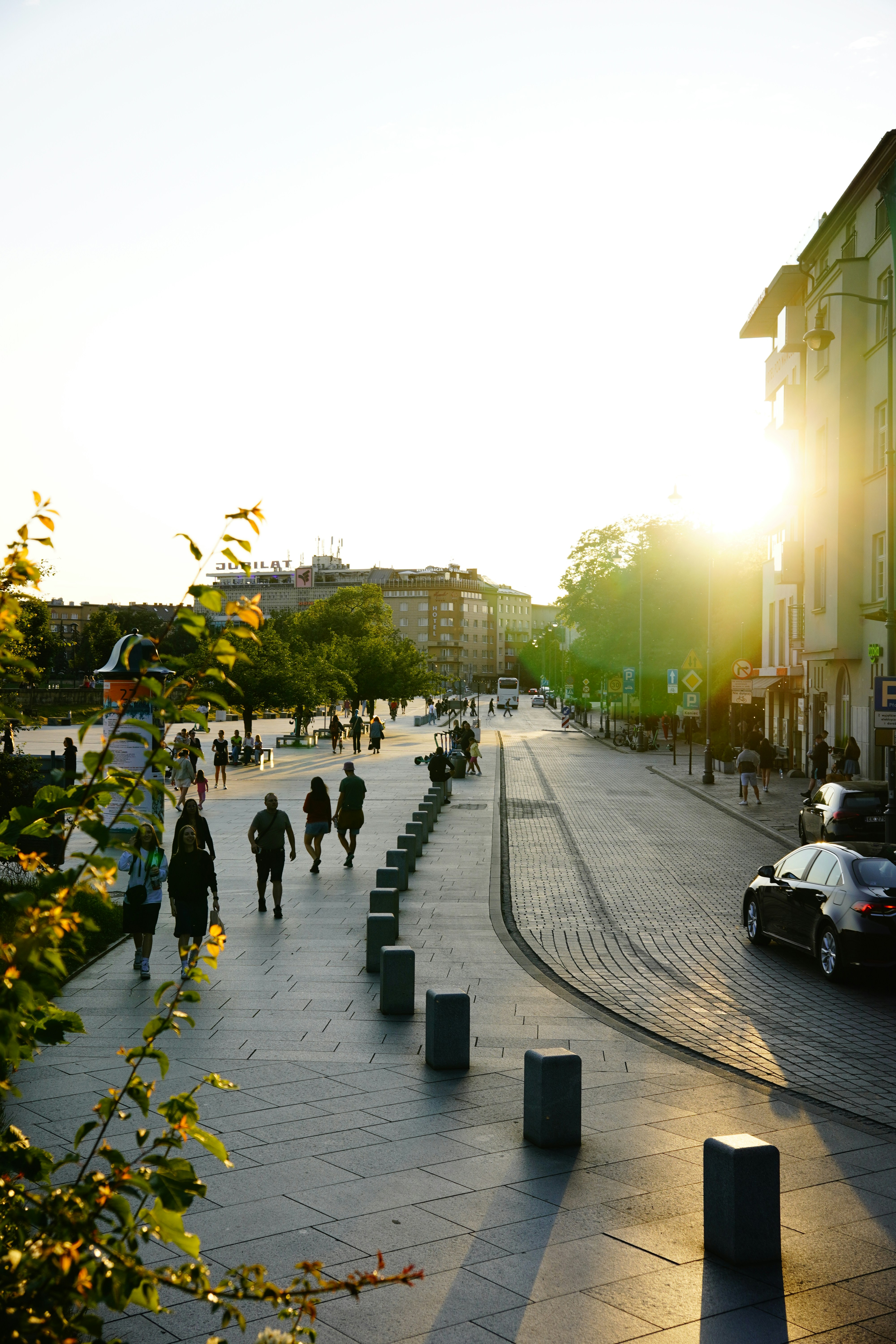 Golden Hour Promenade: People, Pipes, and Width of the Street