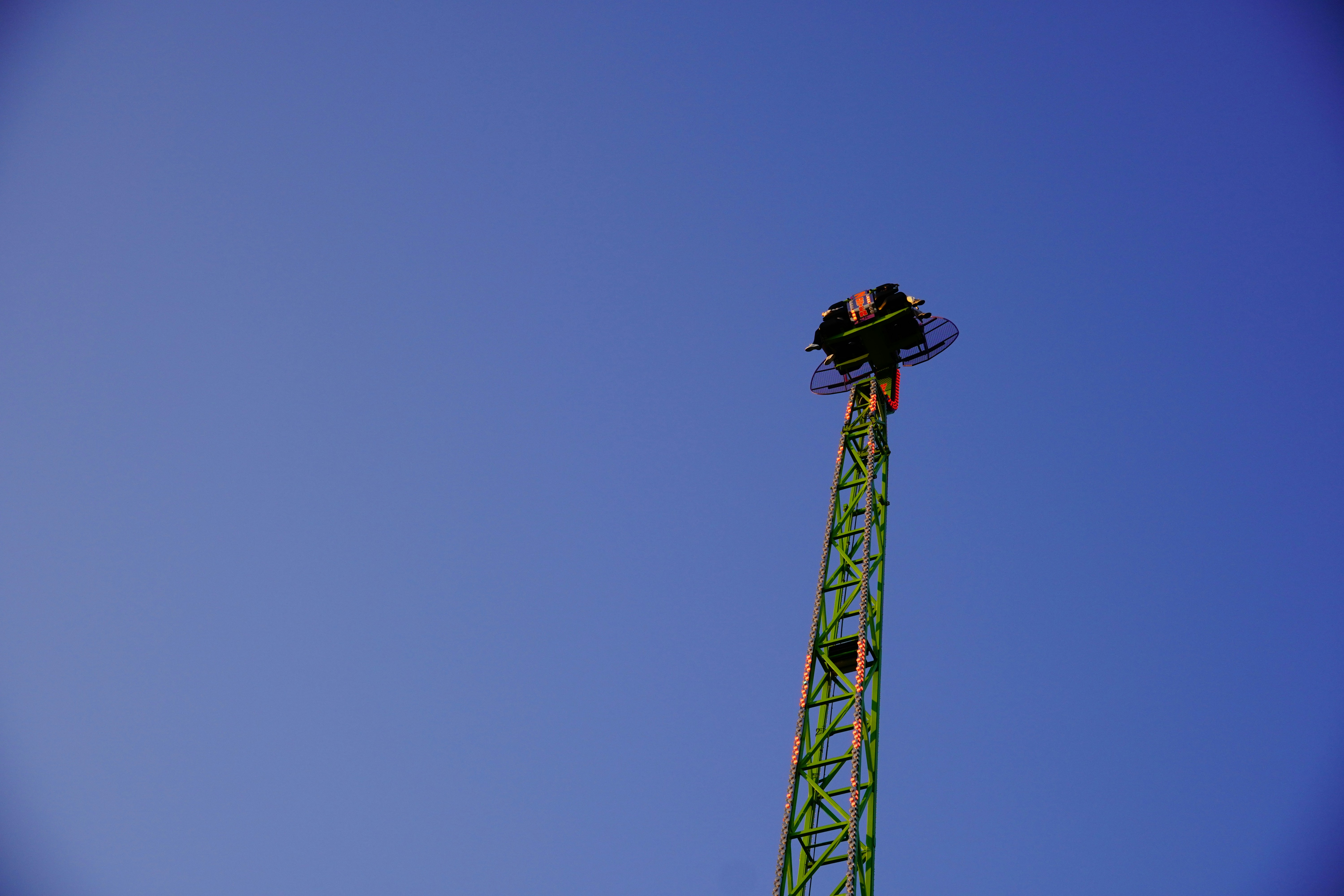 Towering Crane Crowned by a Narrow Platform Against a Clear Sky