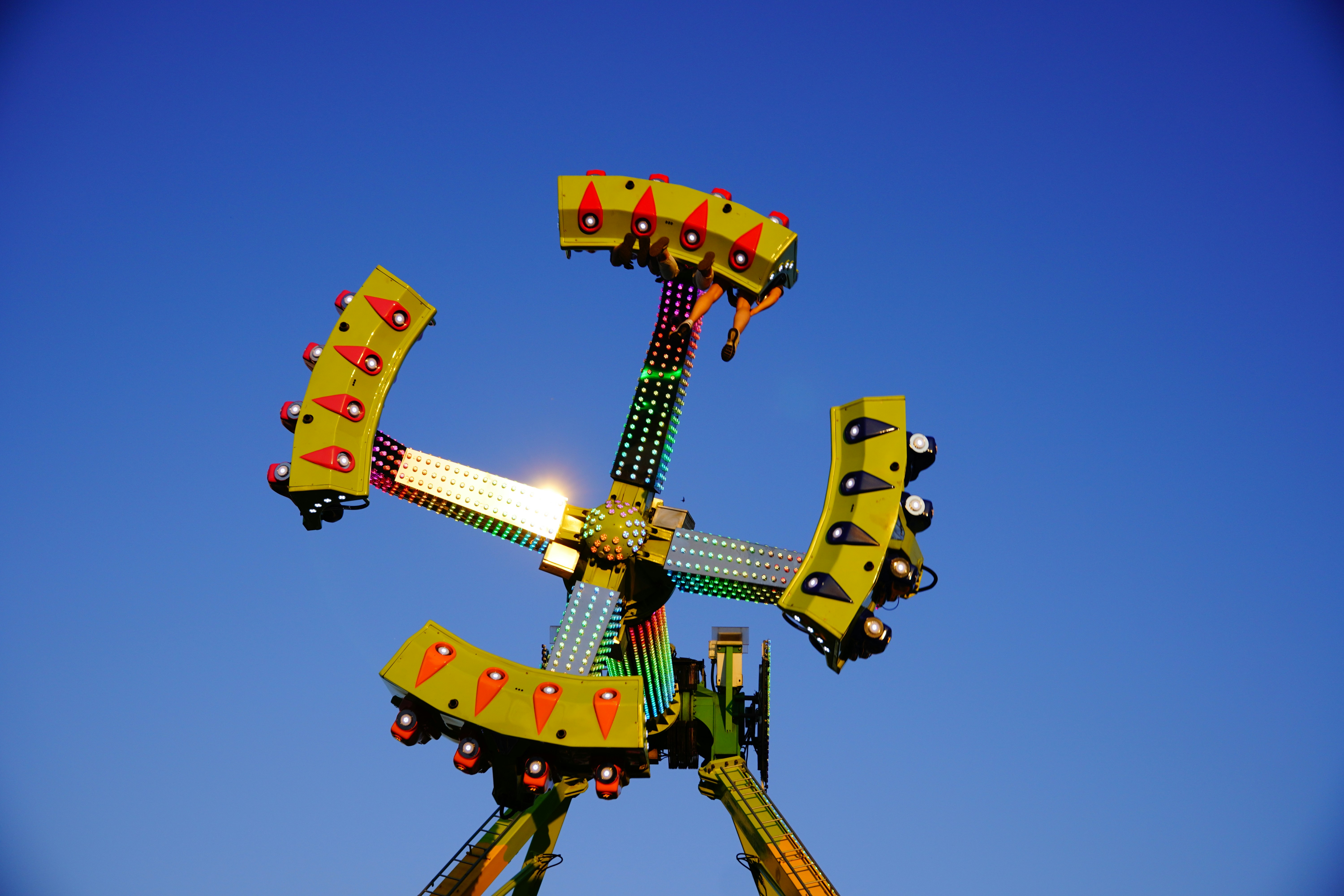 Rotating carnival arms reach for the blue sky