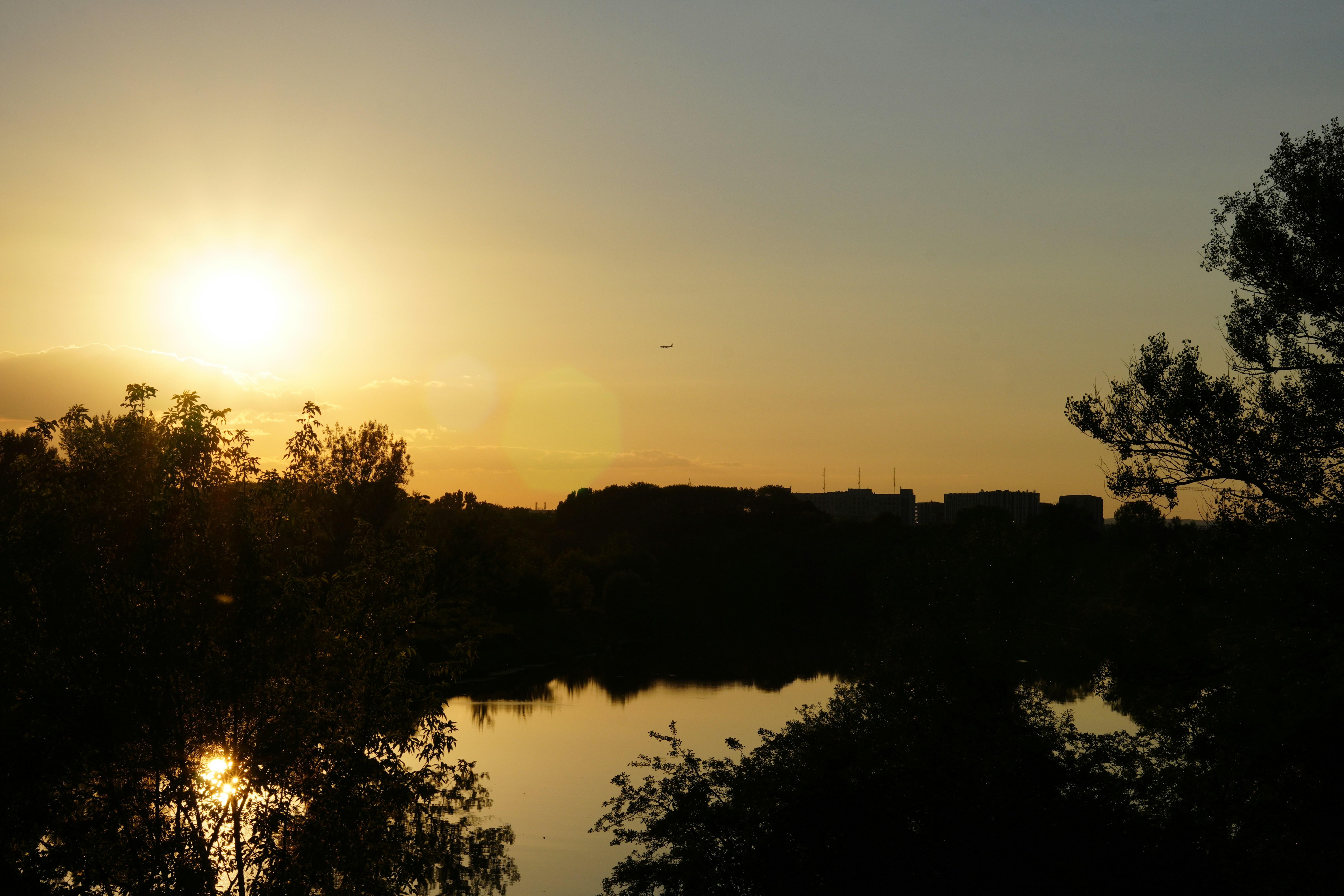 Twin Silhouette: Sunset Reflections on a Quiet Lake
