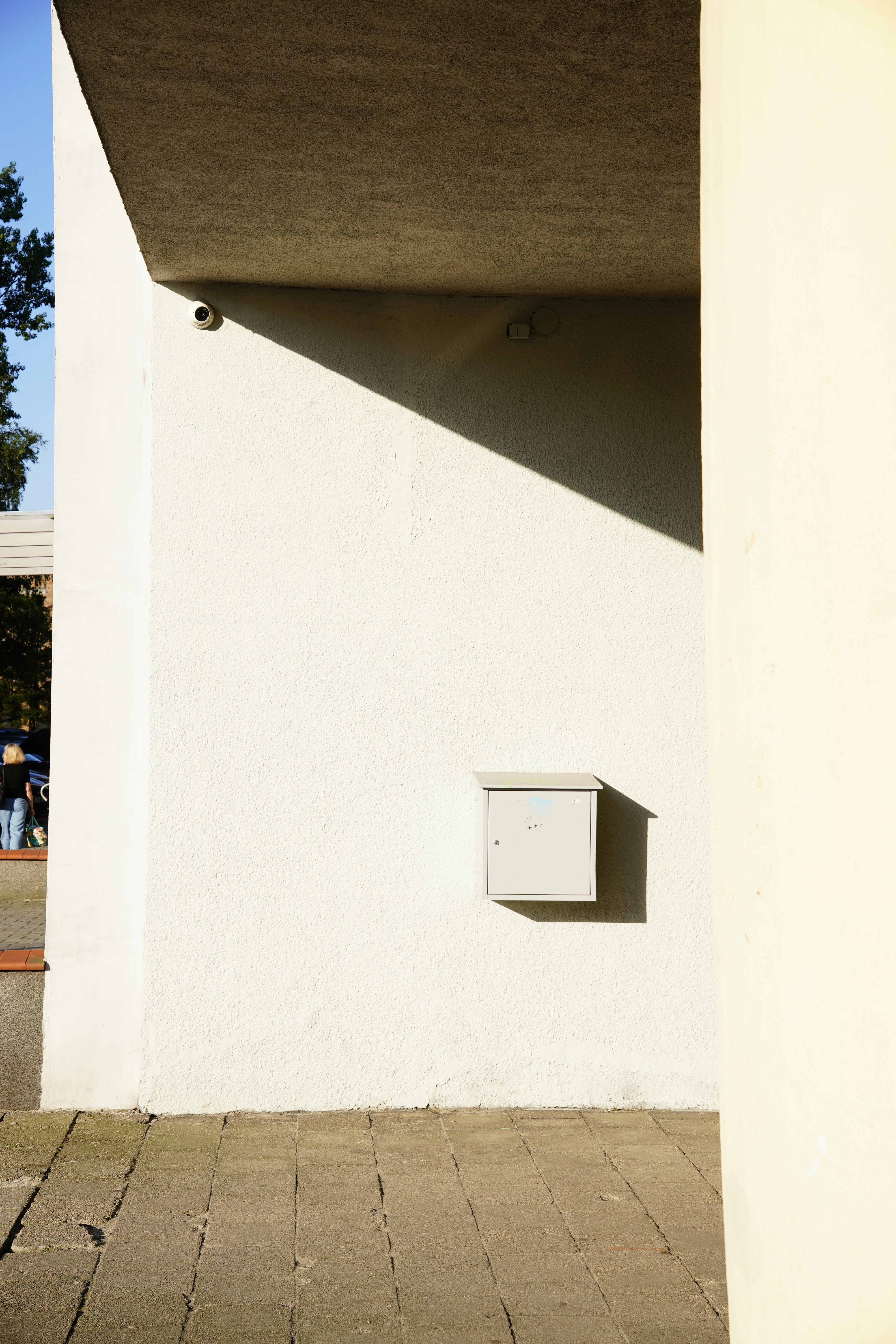 Sunlit Nook: The Quiet Mailbox on a White Wall