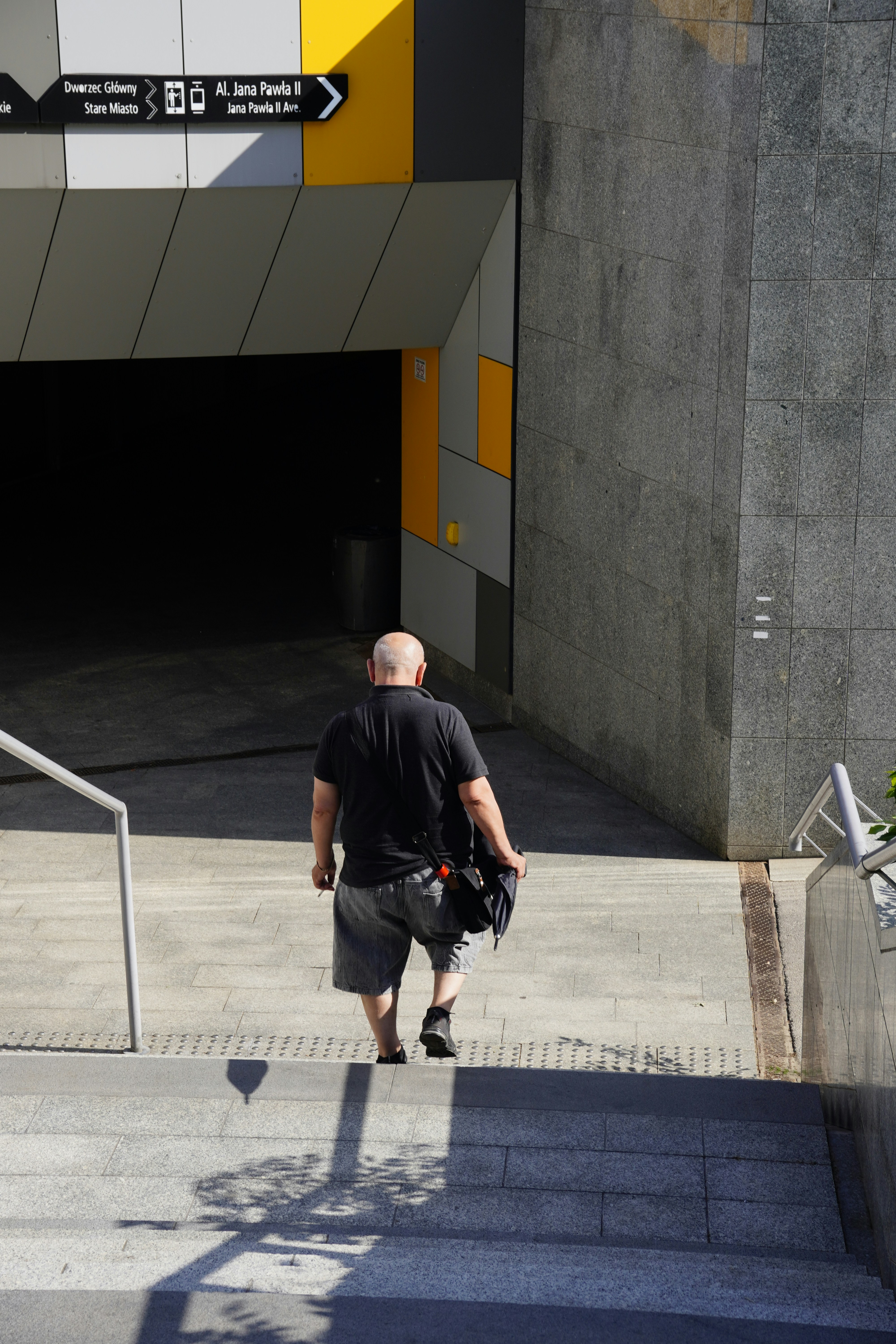 Step into the Light: A lone man ascends toward an urban entryway