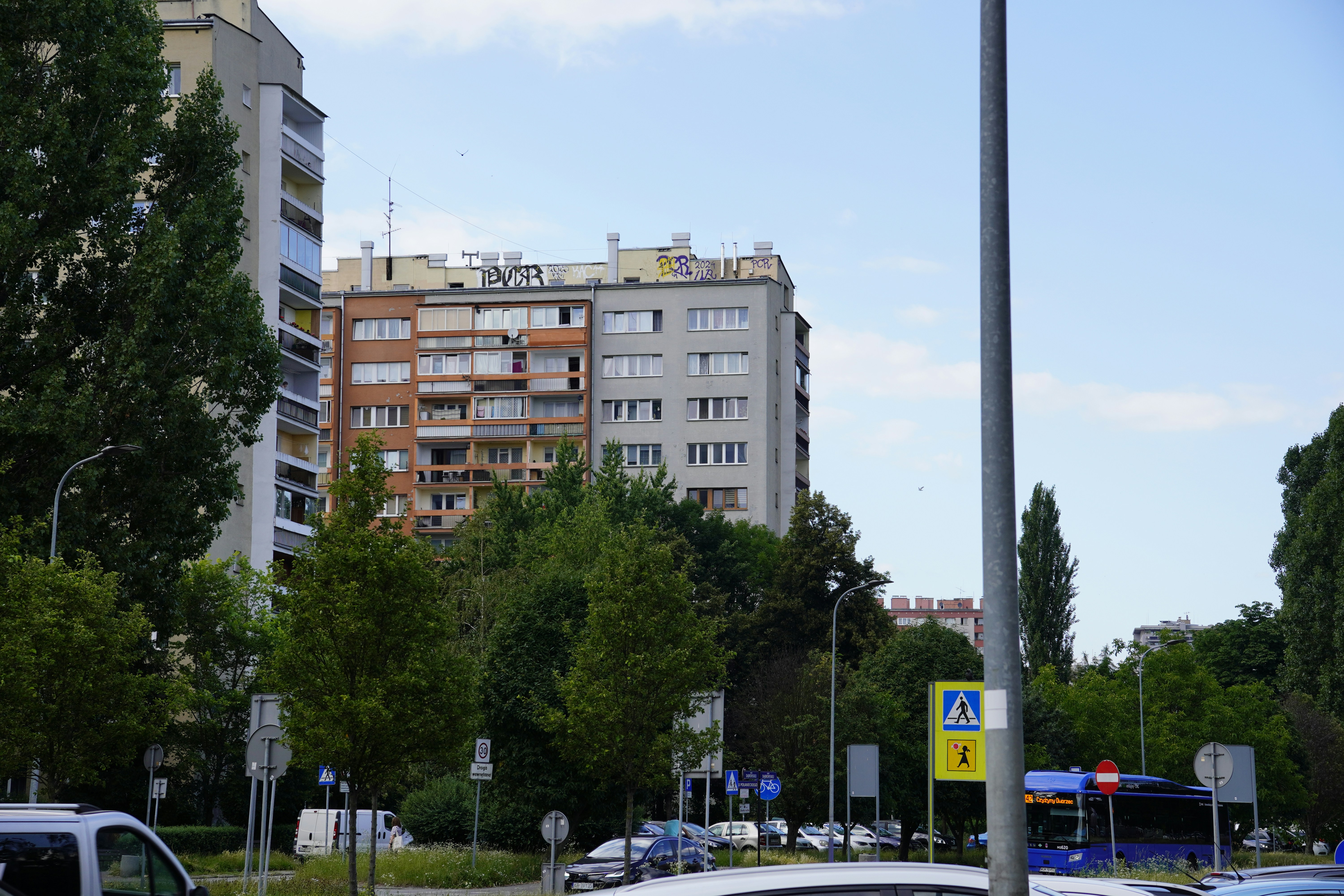 Urban Tapestry: Midday Street Scene with Tall Residential Backdrop