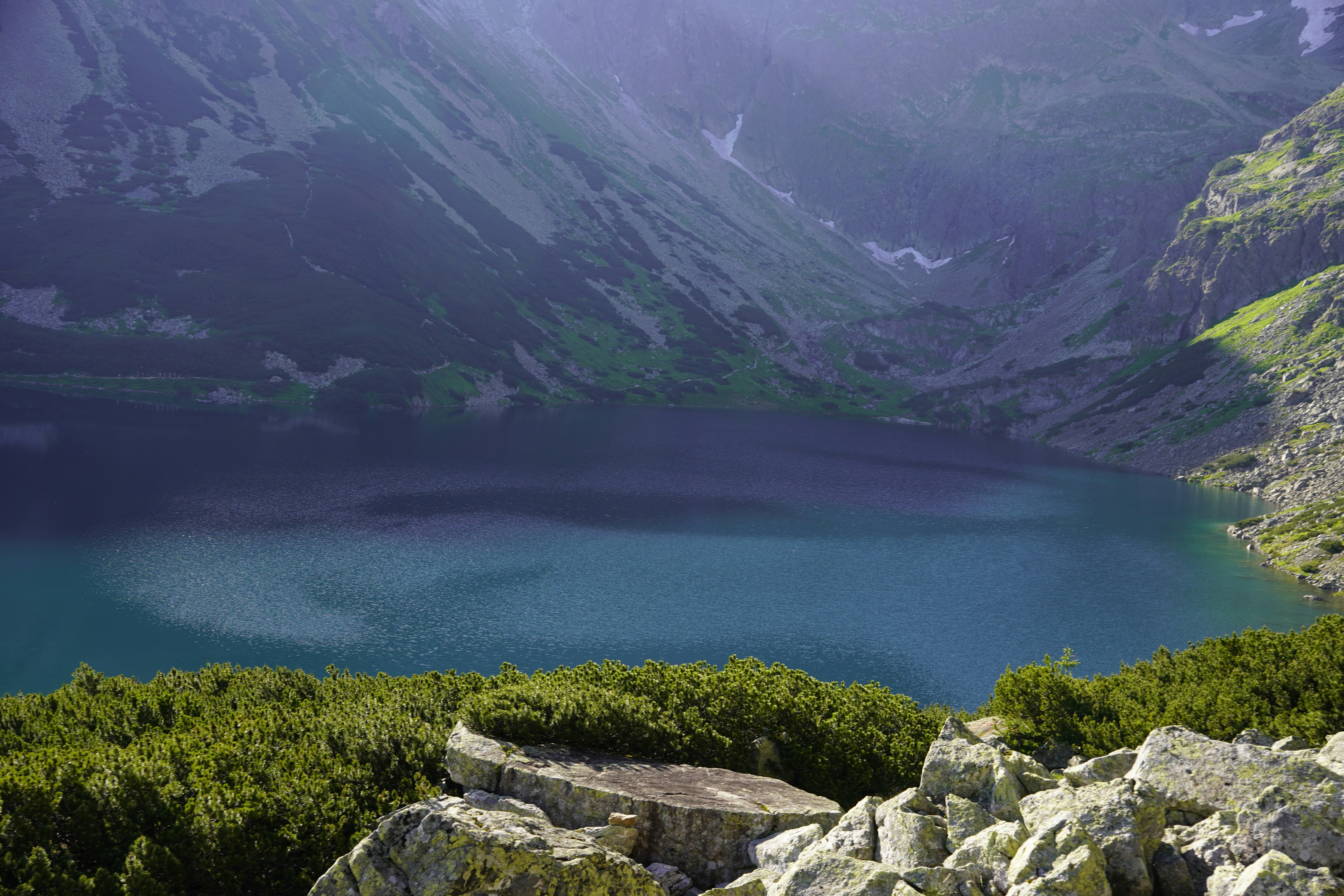 Azure Crater Mirror: Mountain Lake Amidst Rugged Summit