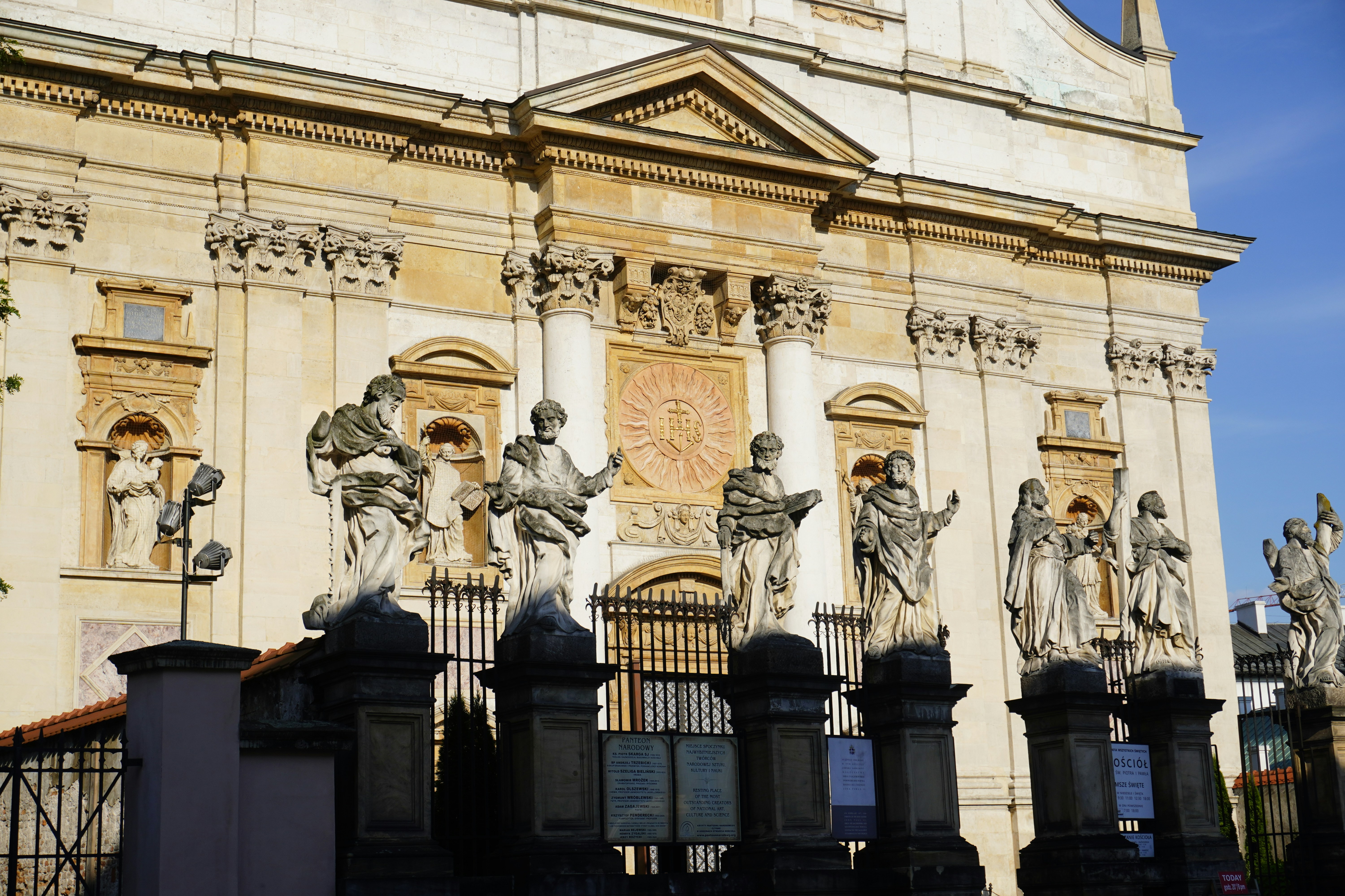 Statues and Facade Arches Under Classical Pediment