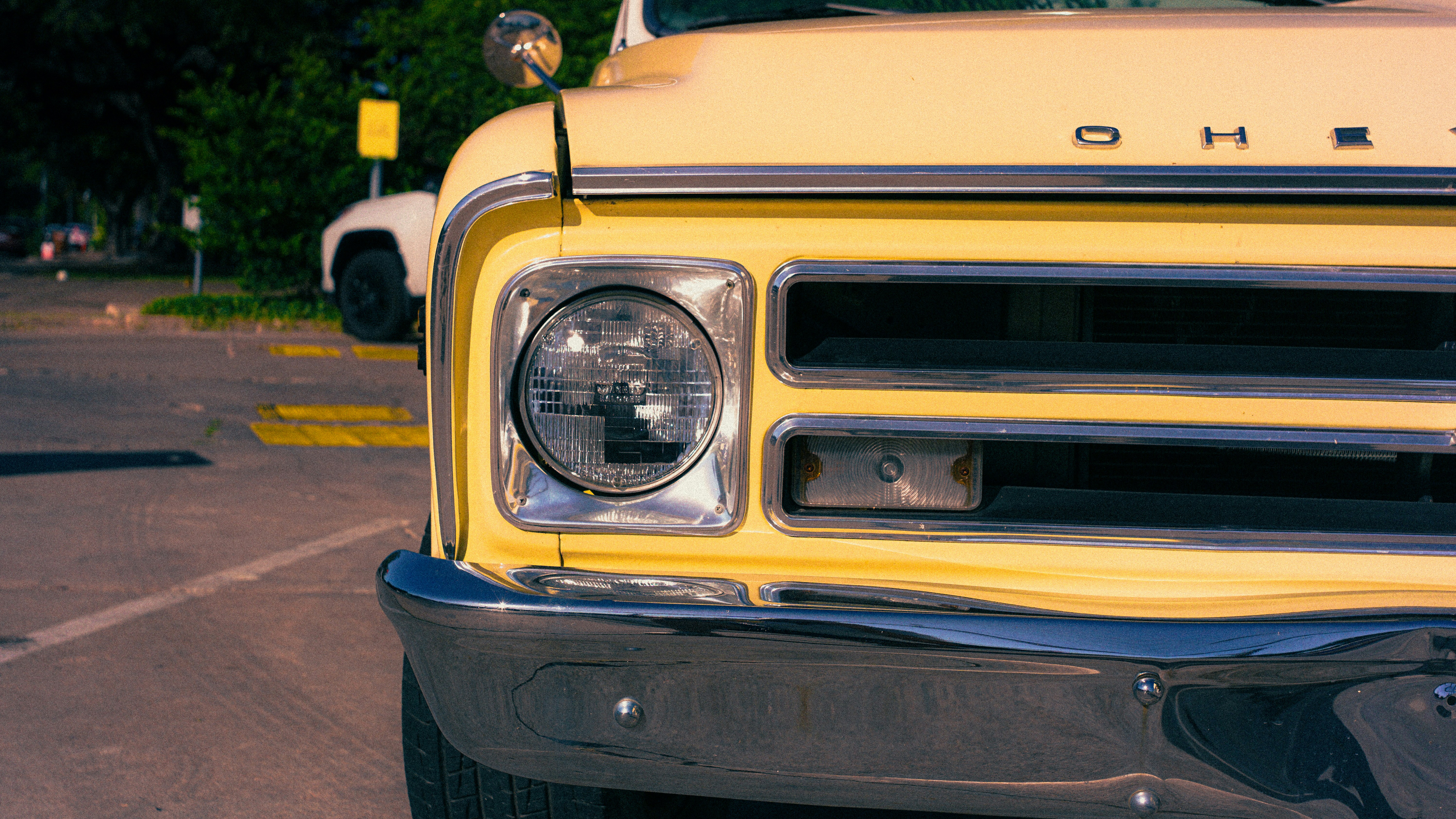 Chrome Grille and Sunrise Yellow: A Close-Up of a Classic Chevy Grill
