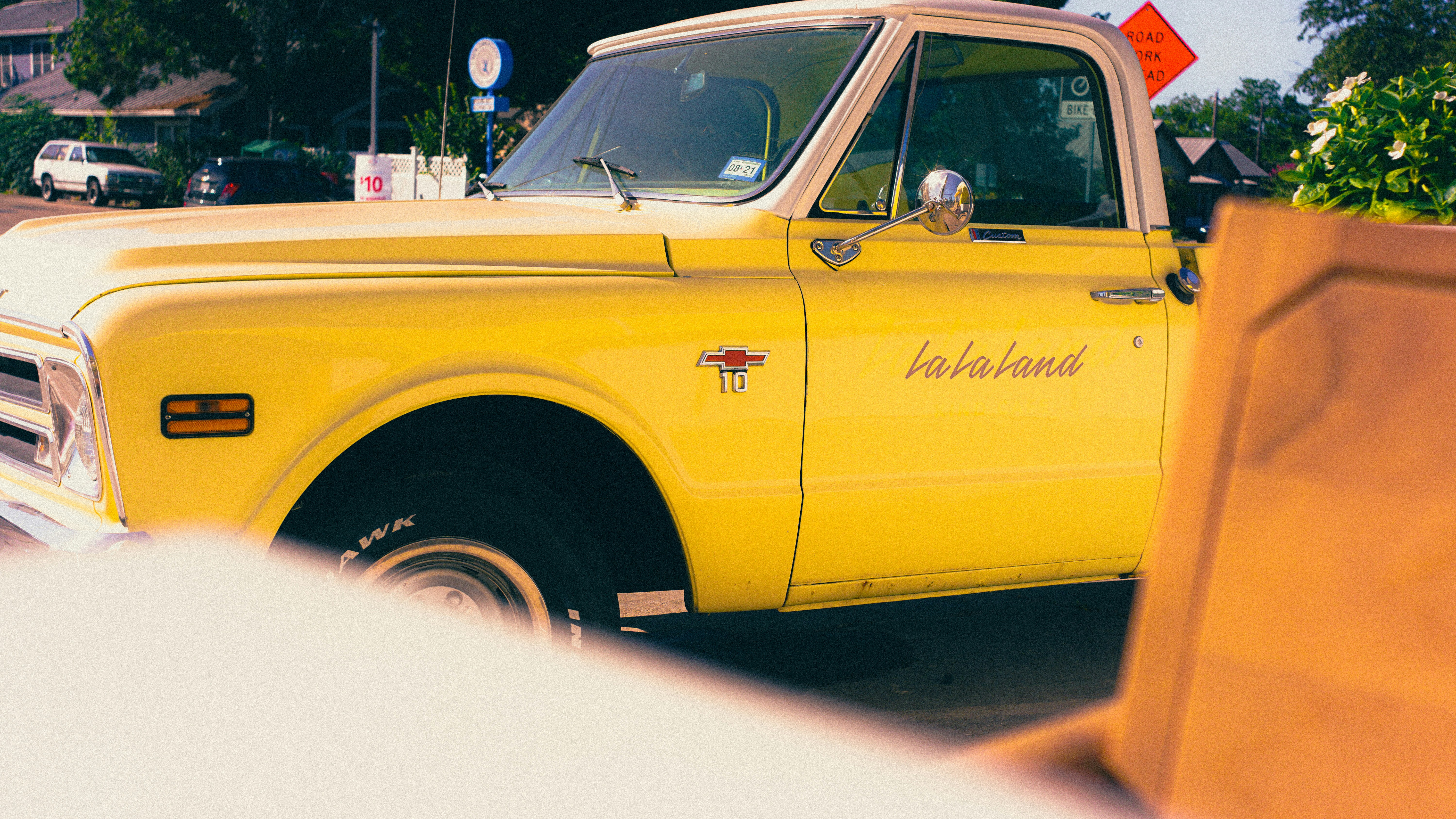 Yellow Ford F-100 Pickup in Sunlit Parking