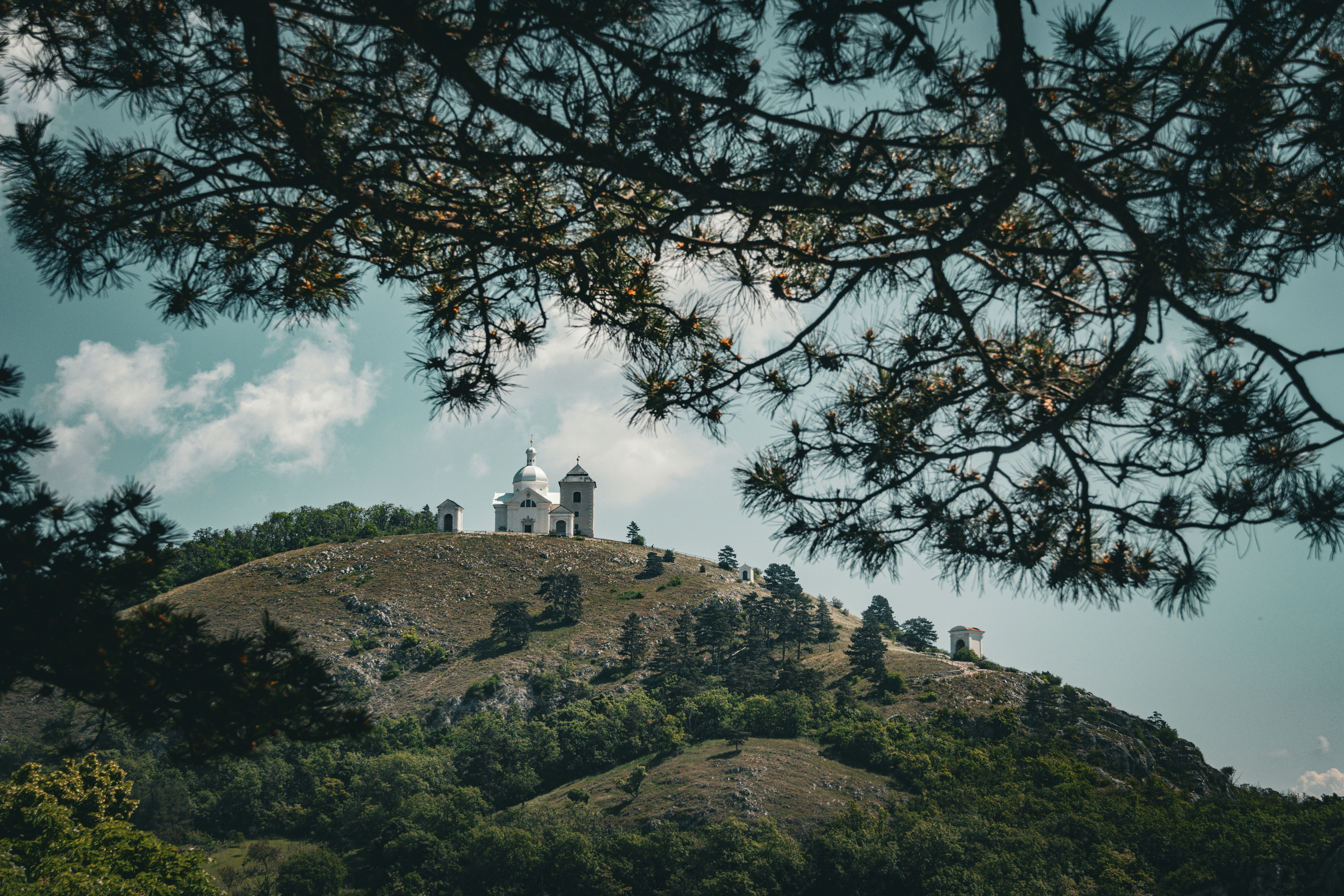Hilltop Chapel Framed by Branches at Dappled Afternoon