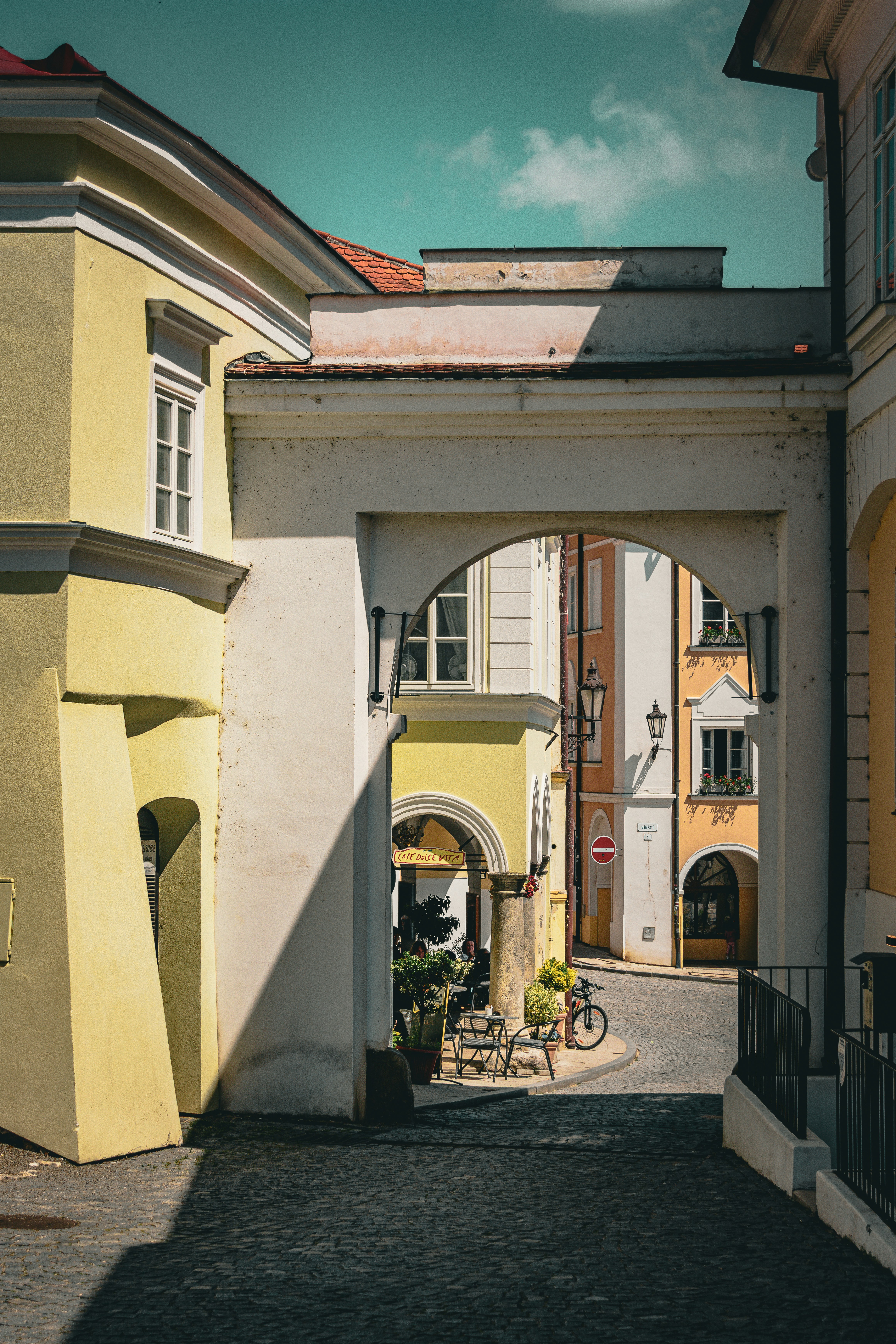 Archway Through a Sunlit European Courtyard