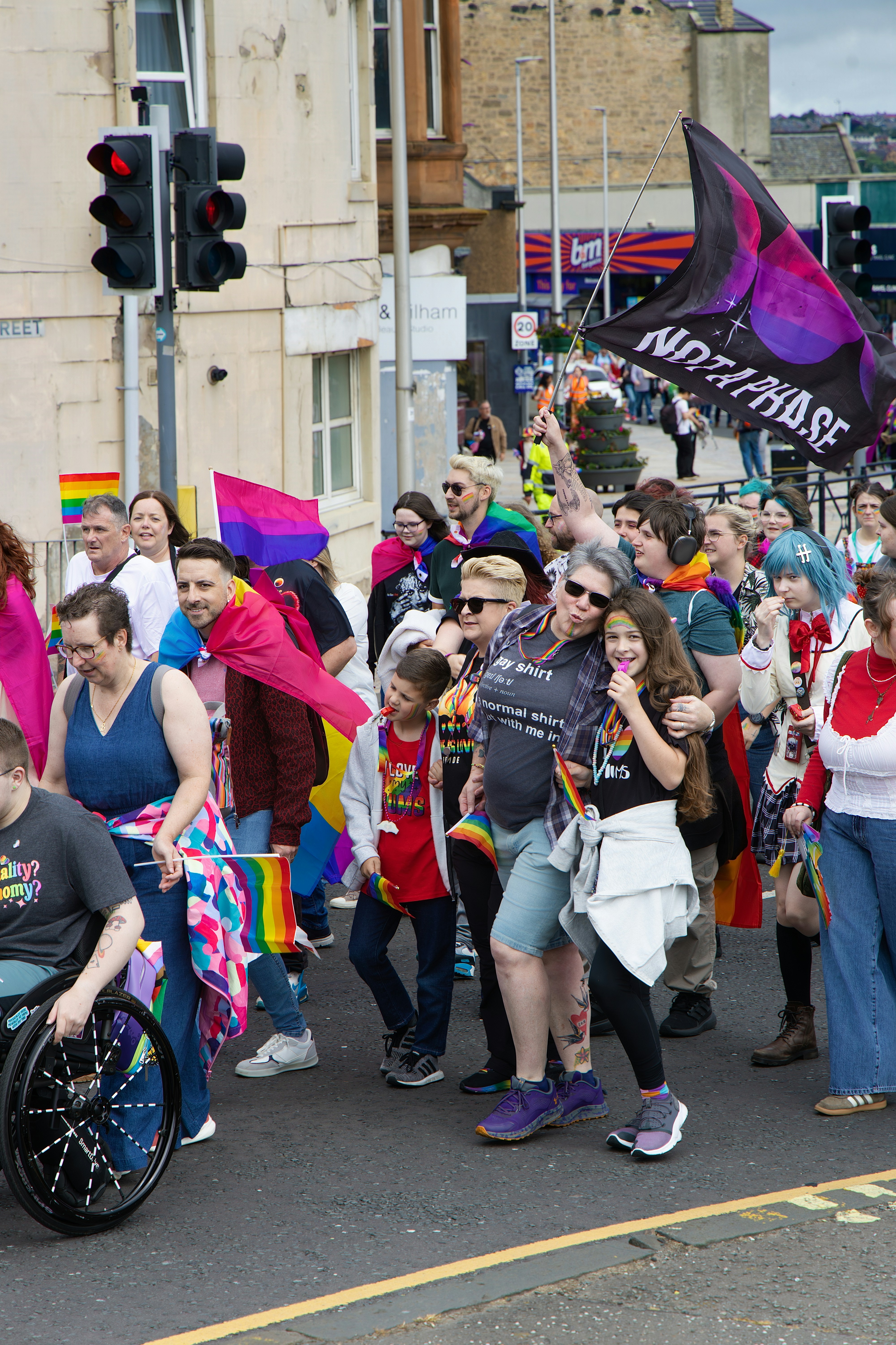 Marching Colors: Pride Parade Through a Bustling Street
