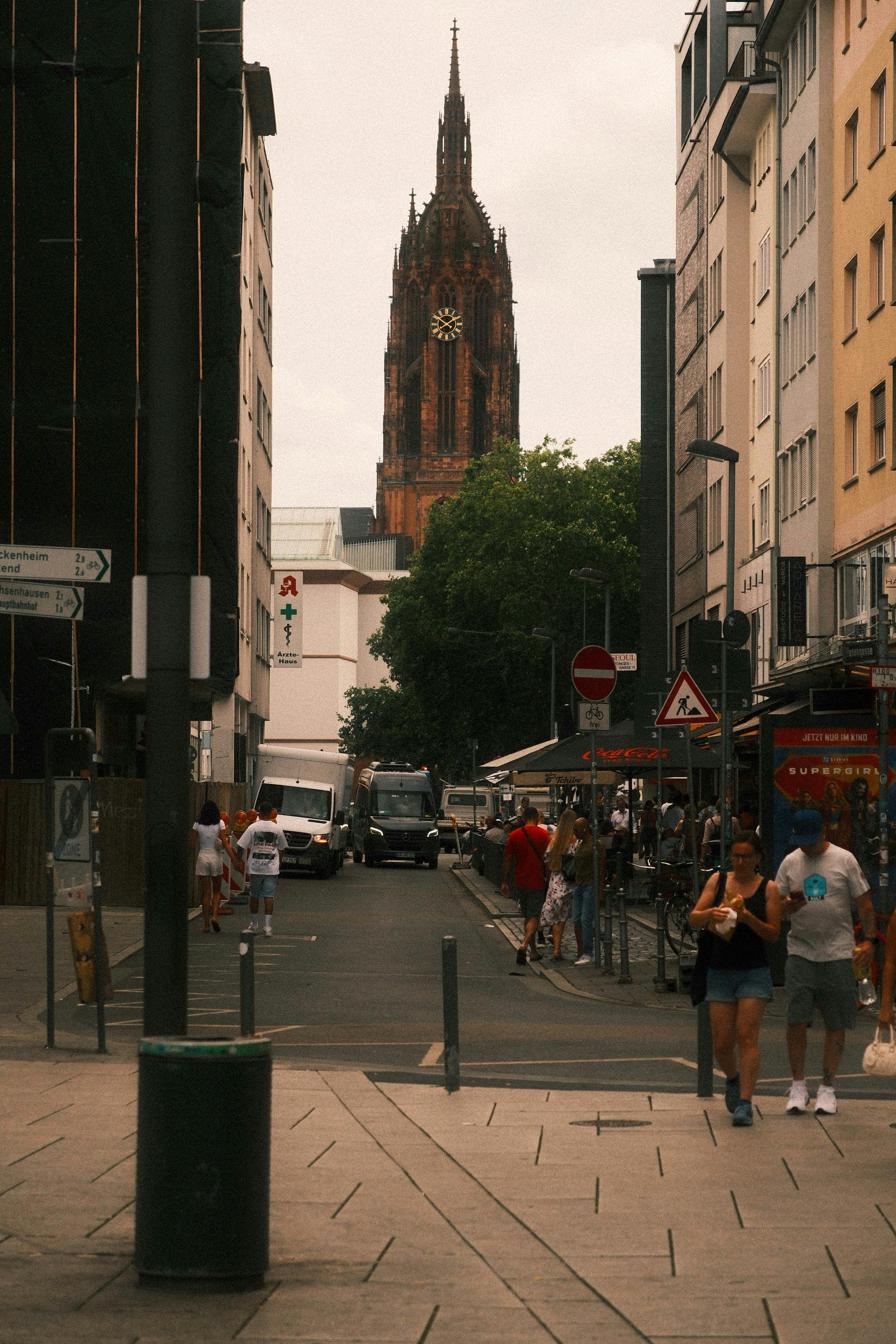 City Street Converges on a Gothic Clock Tower