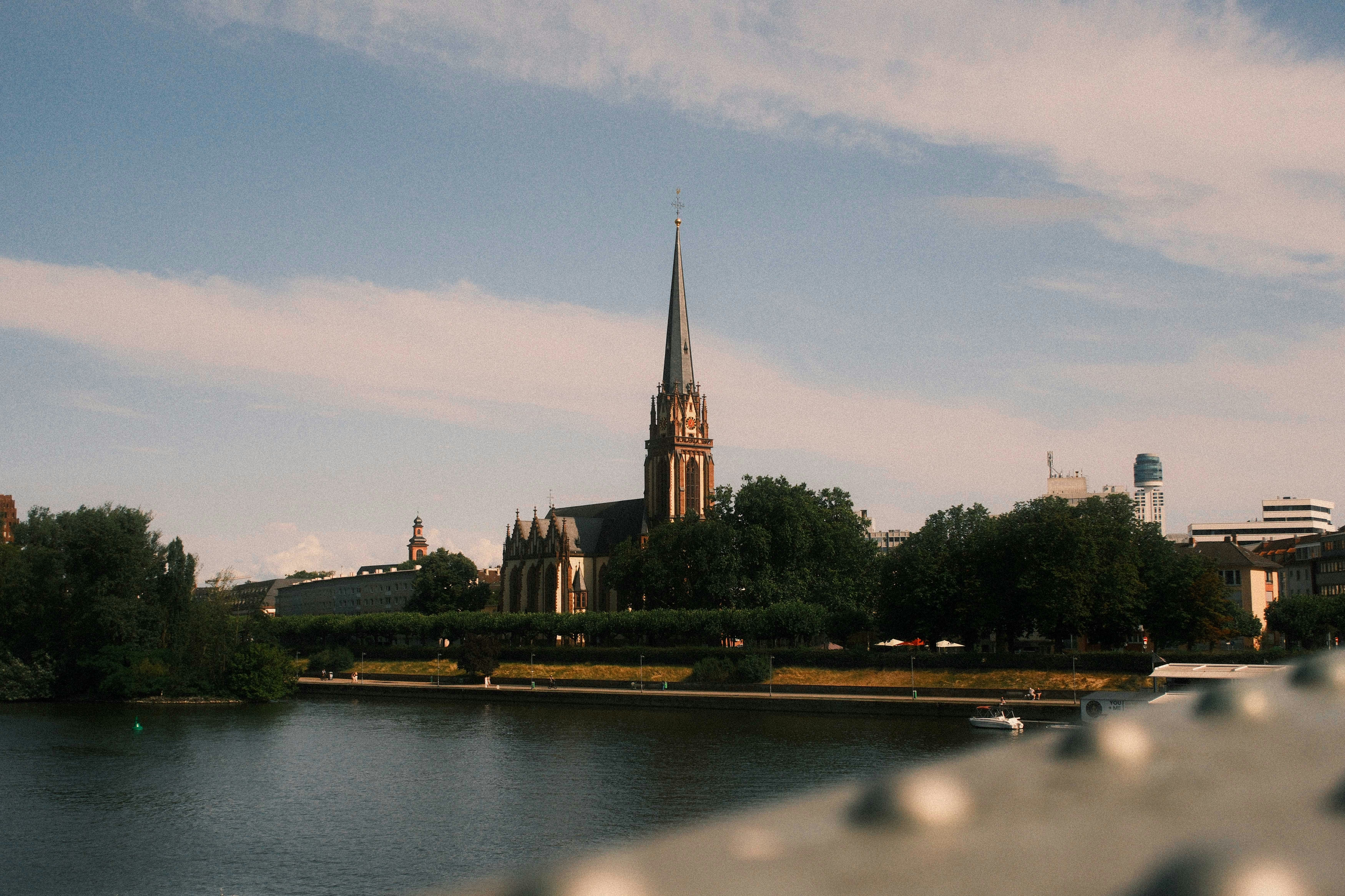 Stately Church Spire Rising Over a Riverside Skyline