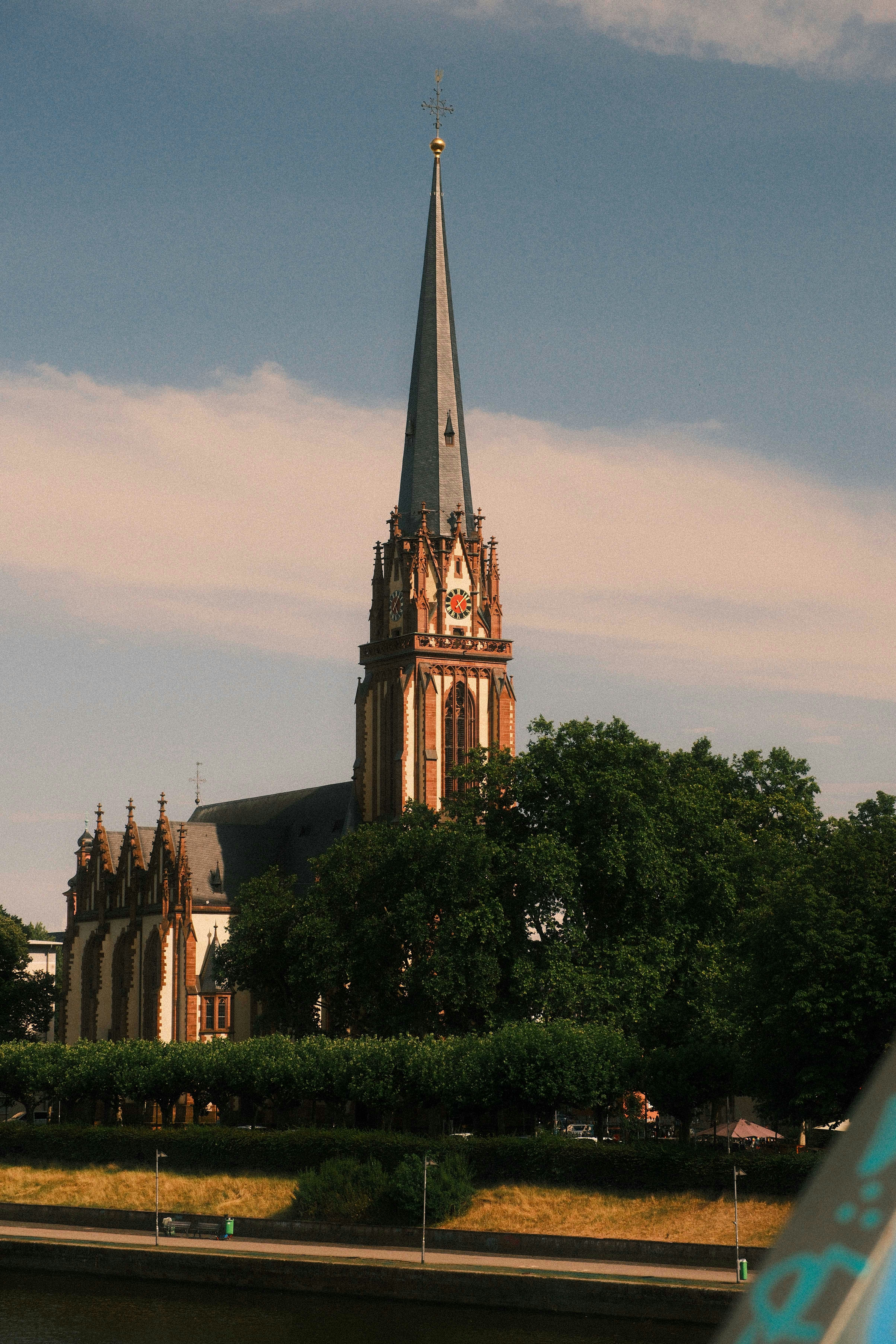 Twin-Tower Spire: A Sunlit Gothic Cathedral Rising Over Riverside Greens