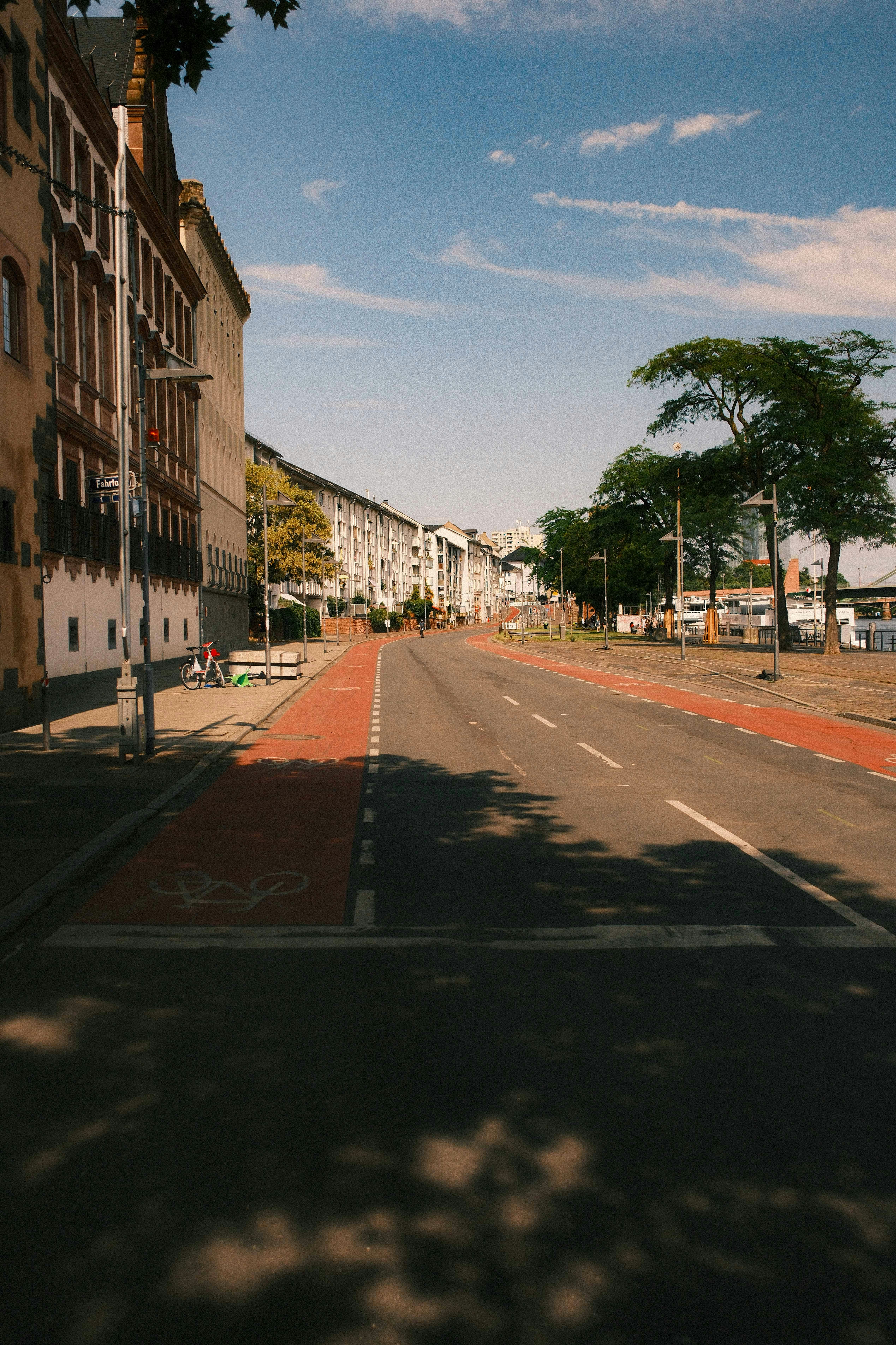 Sunlit Main Street: A Quiet Morning Between Buildings and Trees