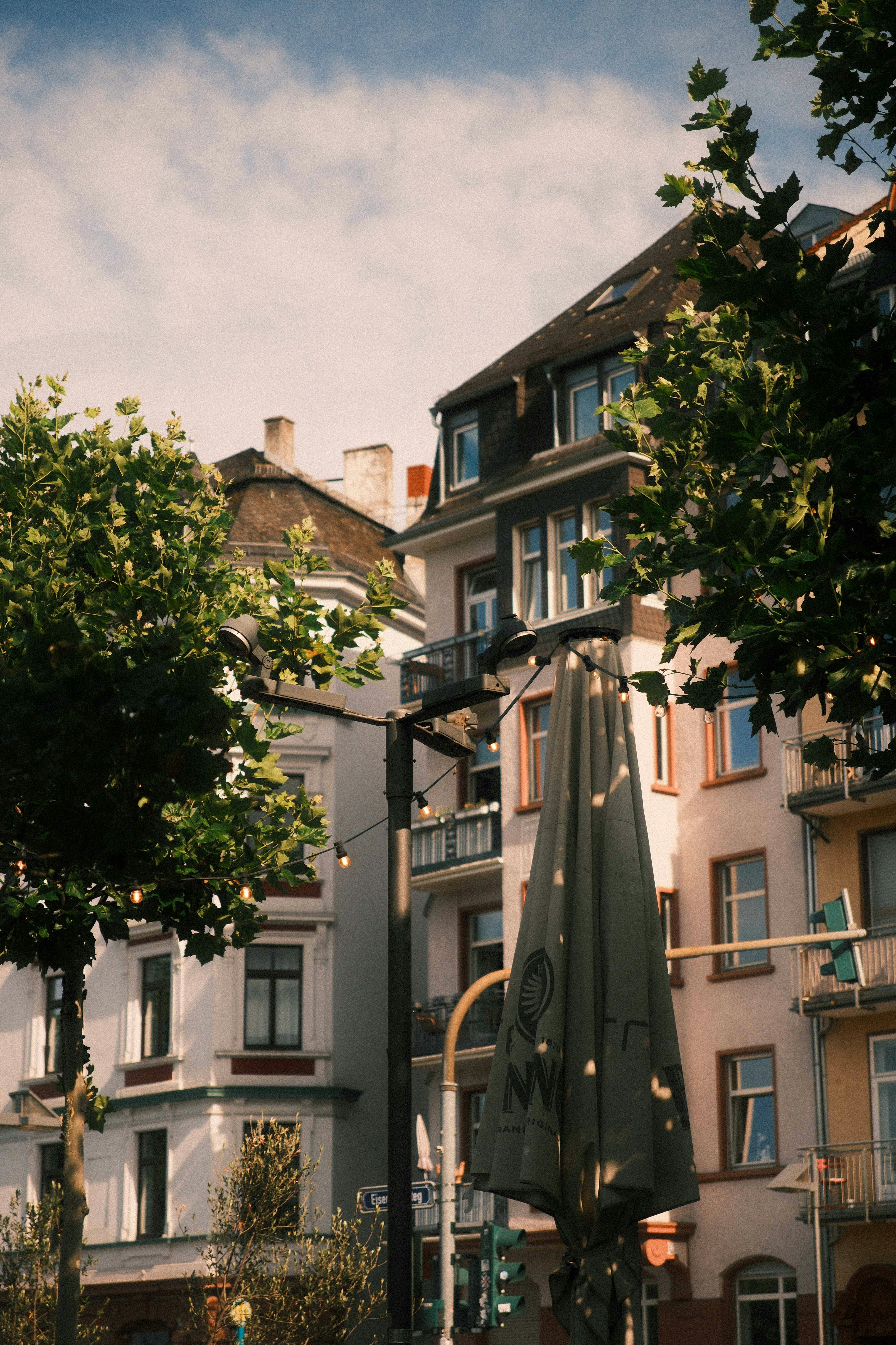 Sunlit European Street with Quiet Café Foreground