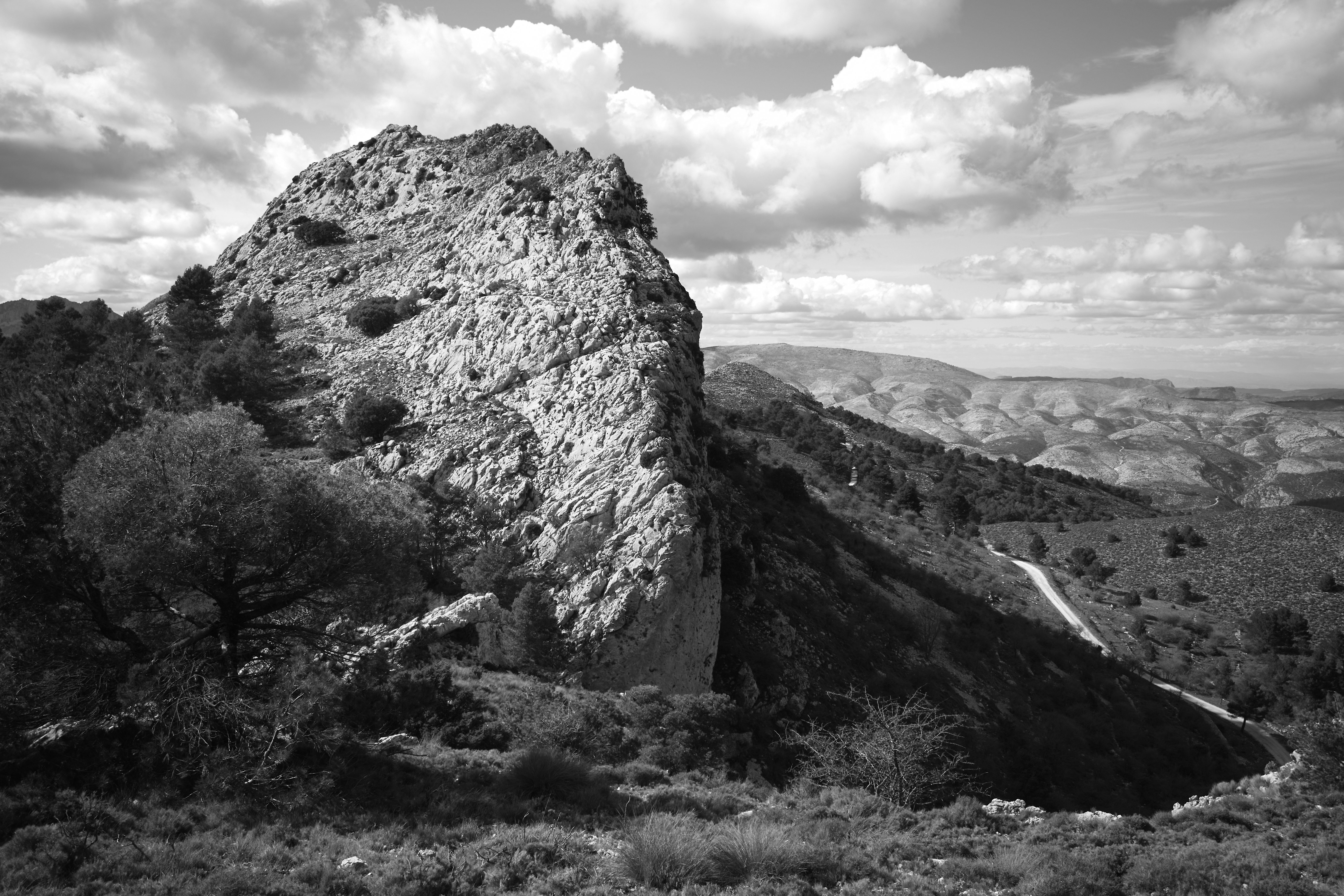 Rugged Outcrop Guarding the Valley Road