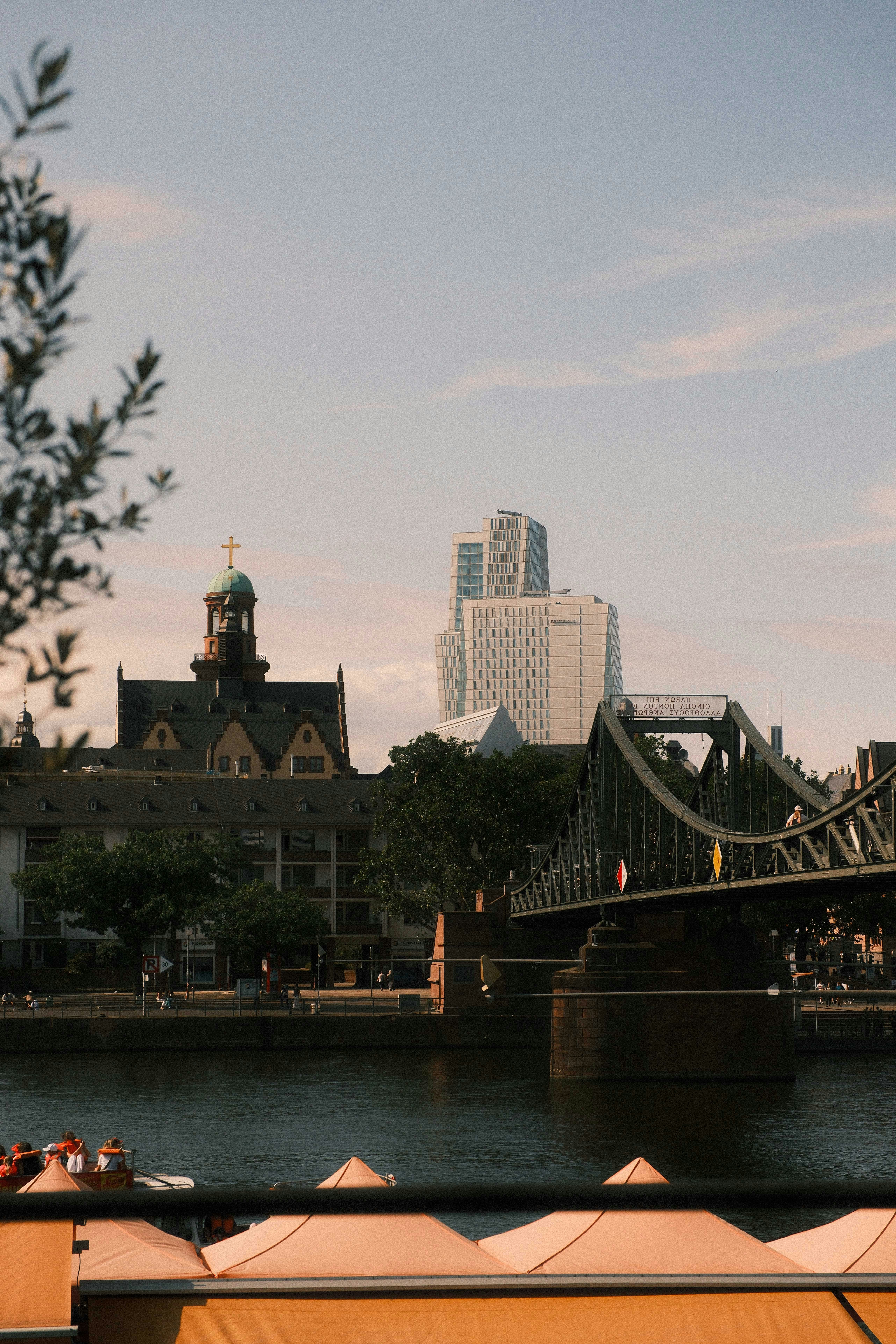 Cityscape Bridge at Dusk: A Quiet Riverfront With Historic and Modern Structures