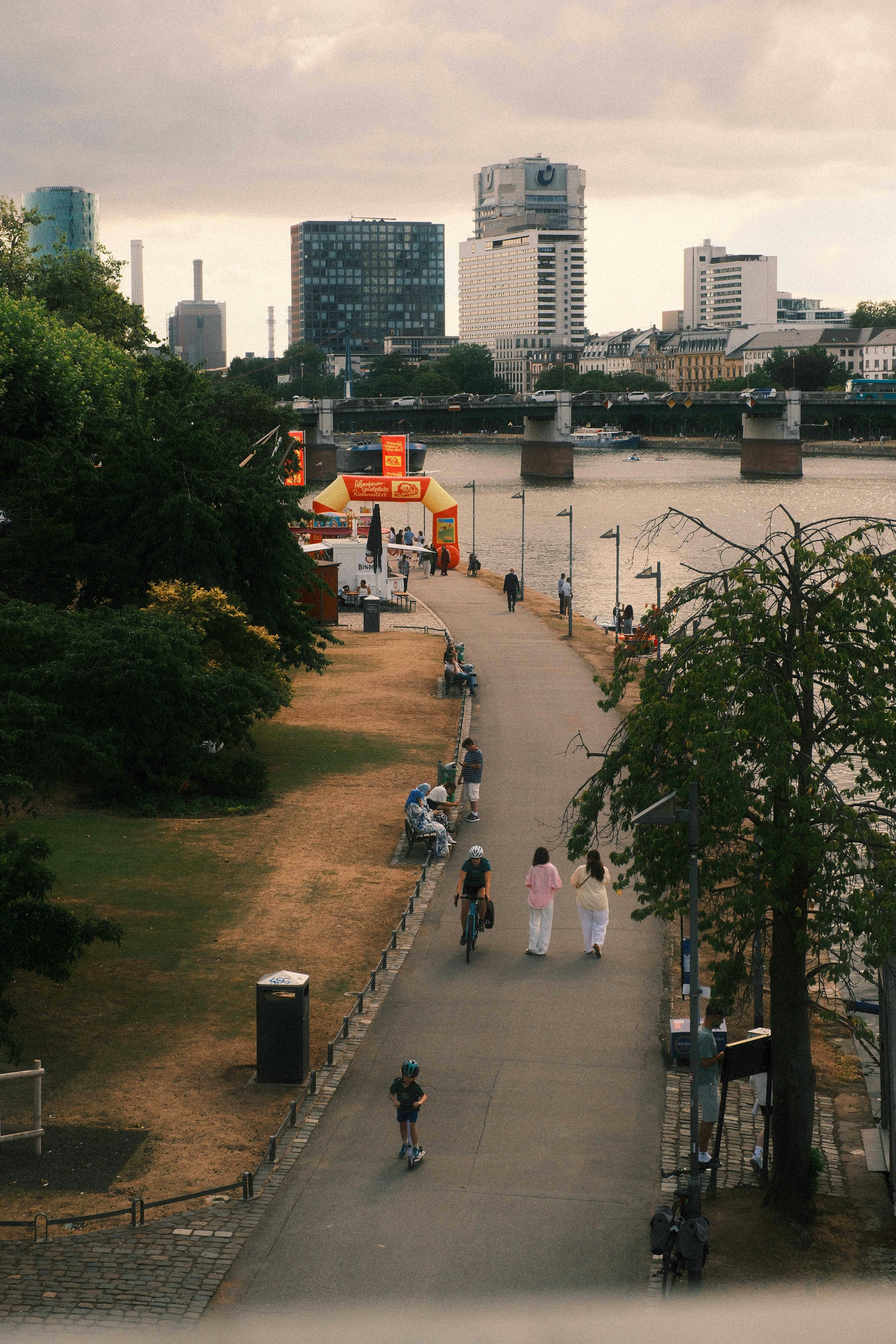 City Riverside Stroll: People, Path, and Promenade